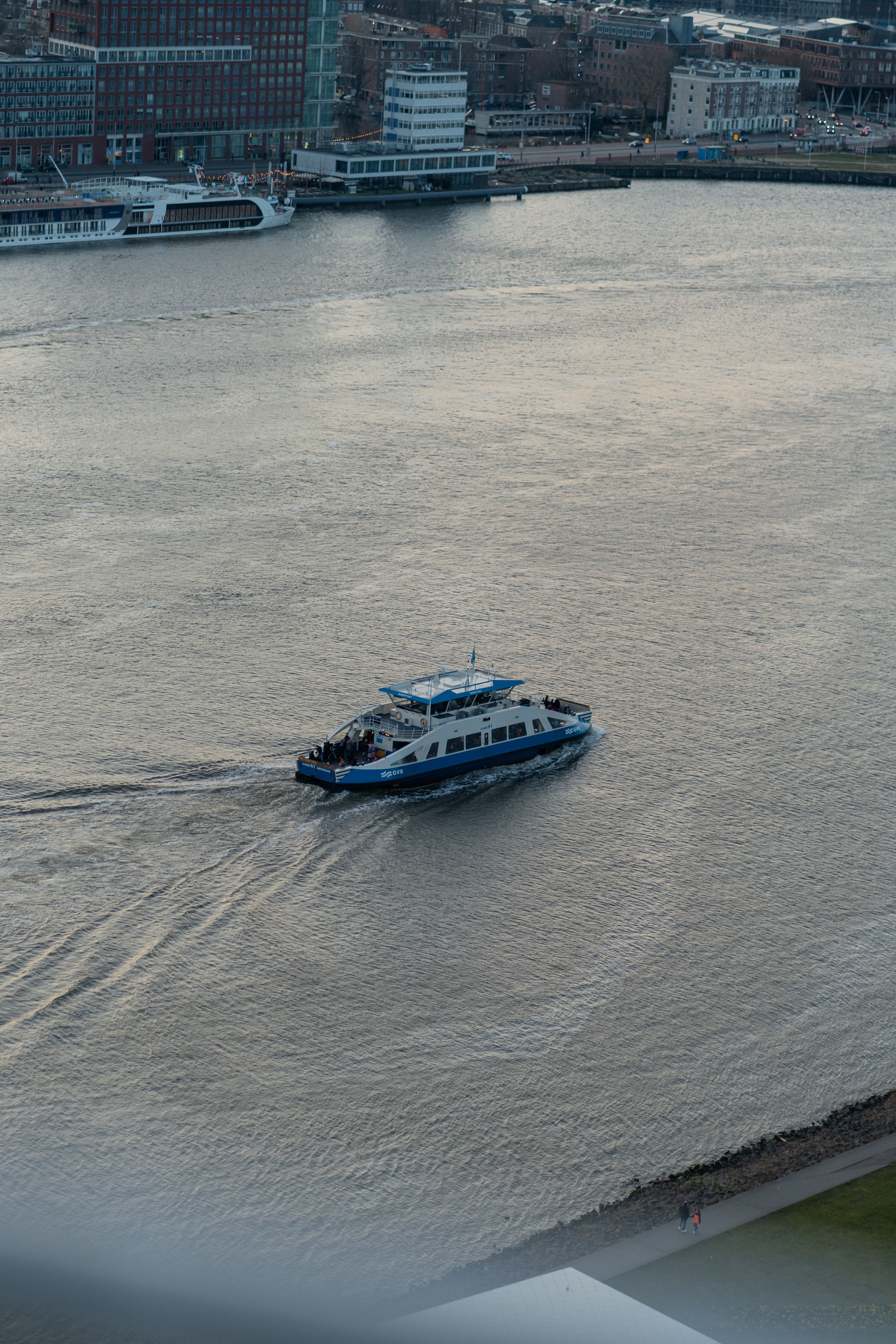 Ferry at a City Waterfront · Free Stock Photo