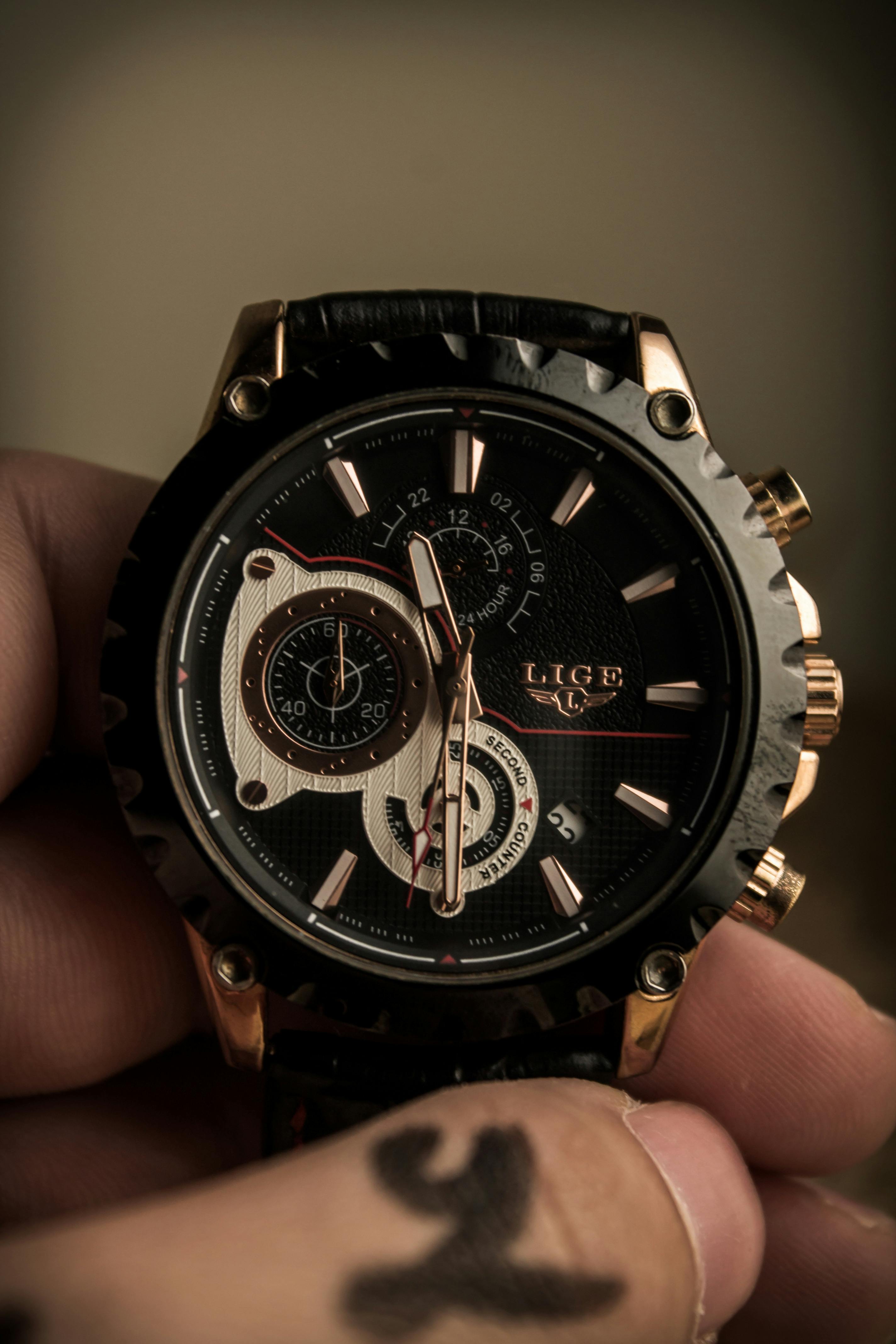 Hand of a Person Holding a Modern Wristwatch · Free Stock Photo