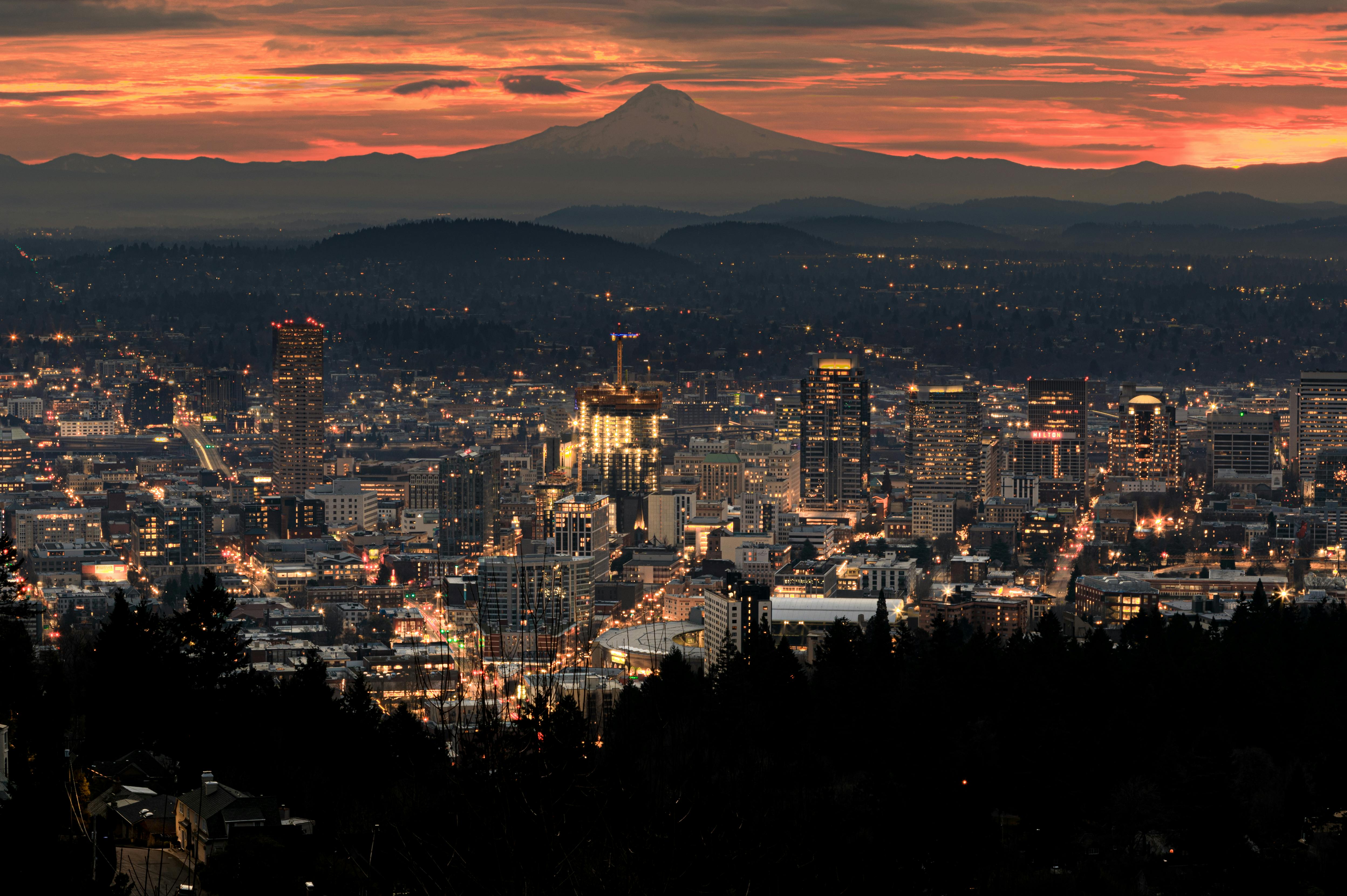 View of Illuminated Buildings in Portland and Mountains in the ...