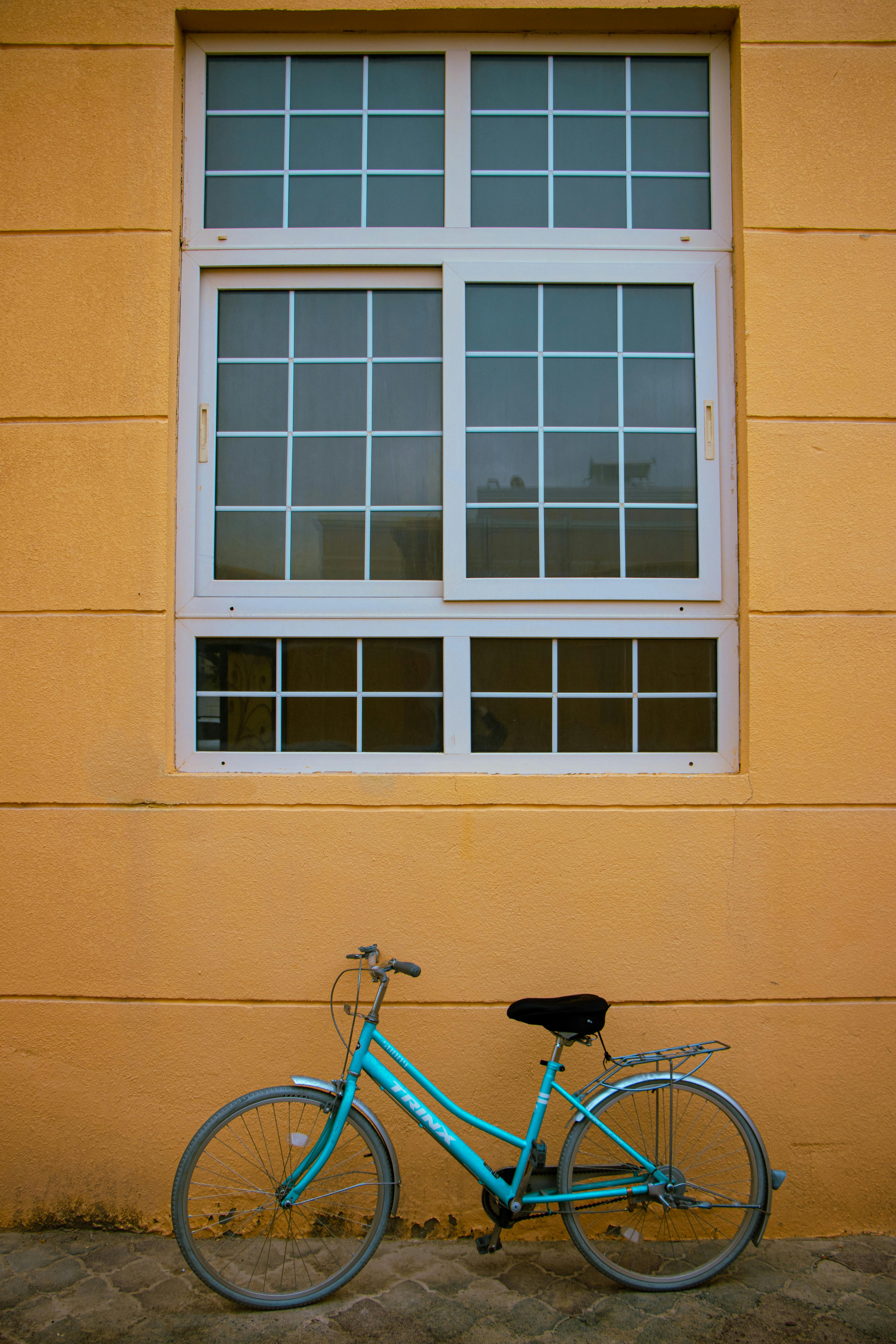 Bicycle by Windows · Free Stock Photo