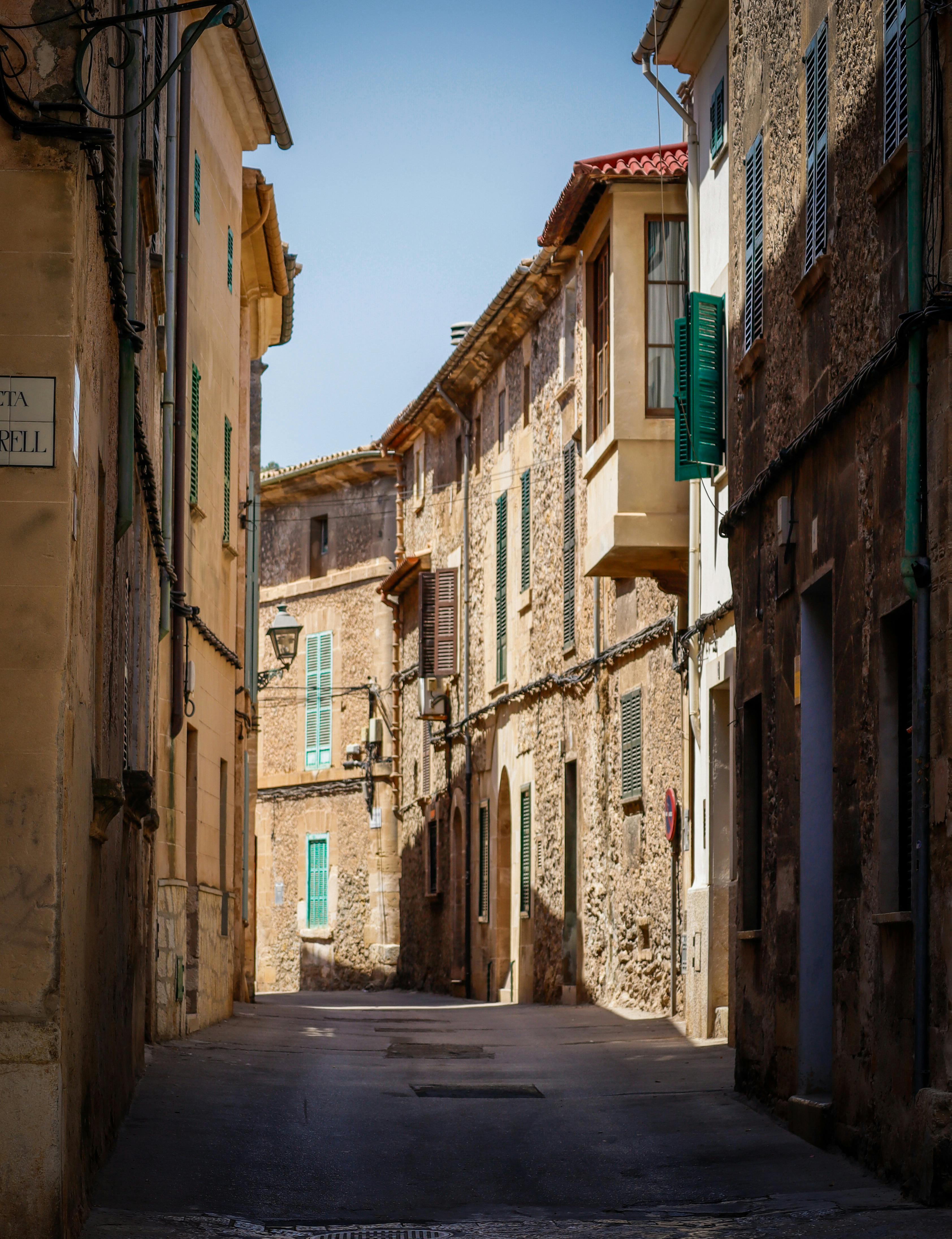 Shadow in Narrow Alley Between Townhouses · Free Stock Photo