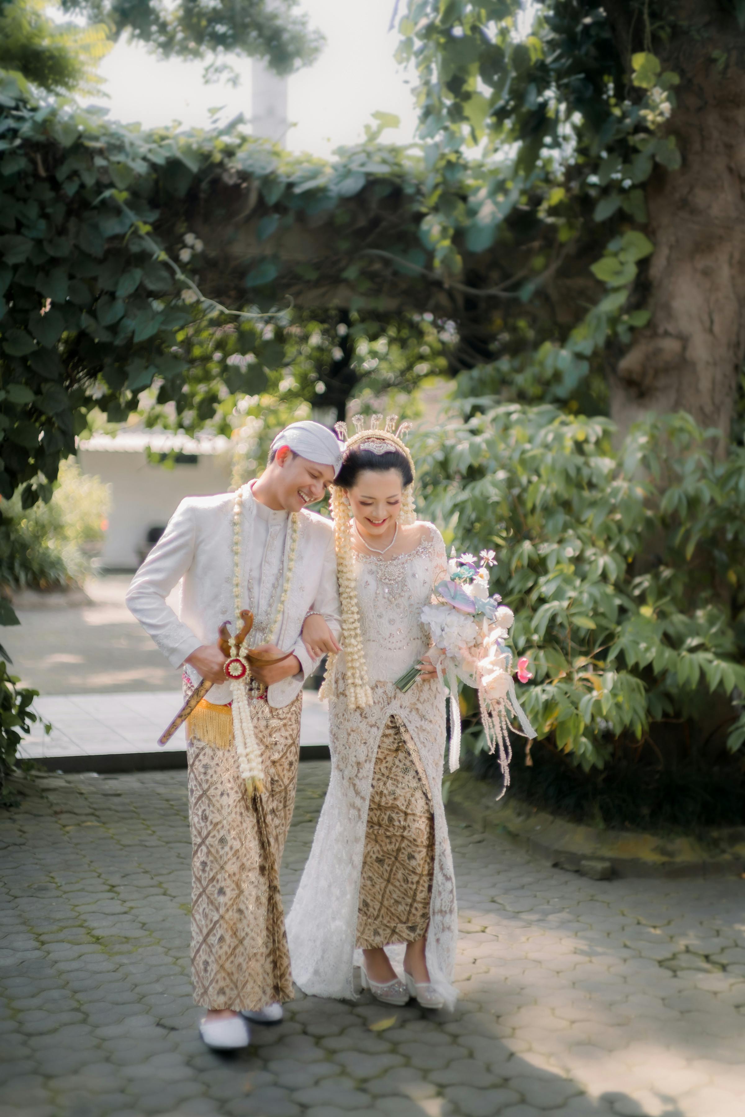 Couple in Traditional Javanese Wedding Clothes in a Park · Free Stock Photo