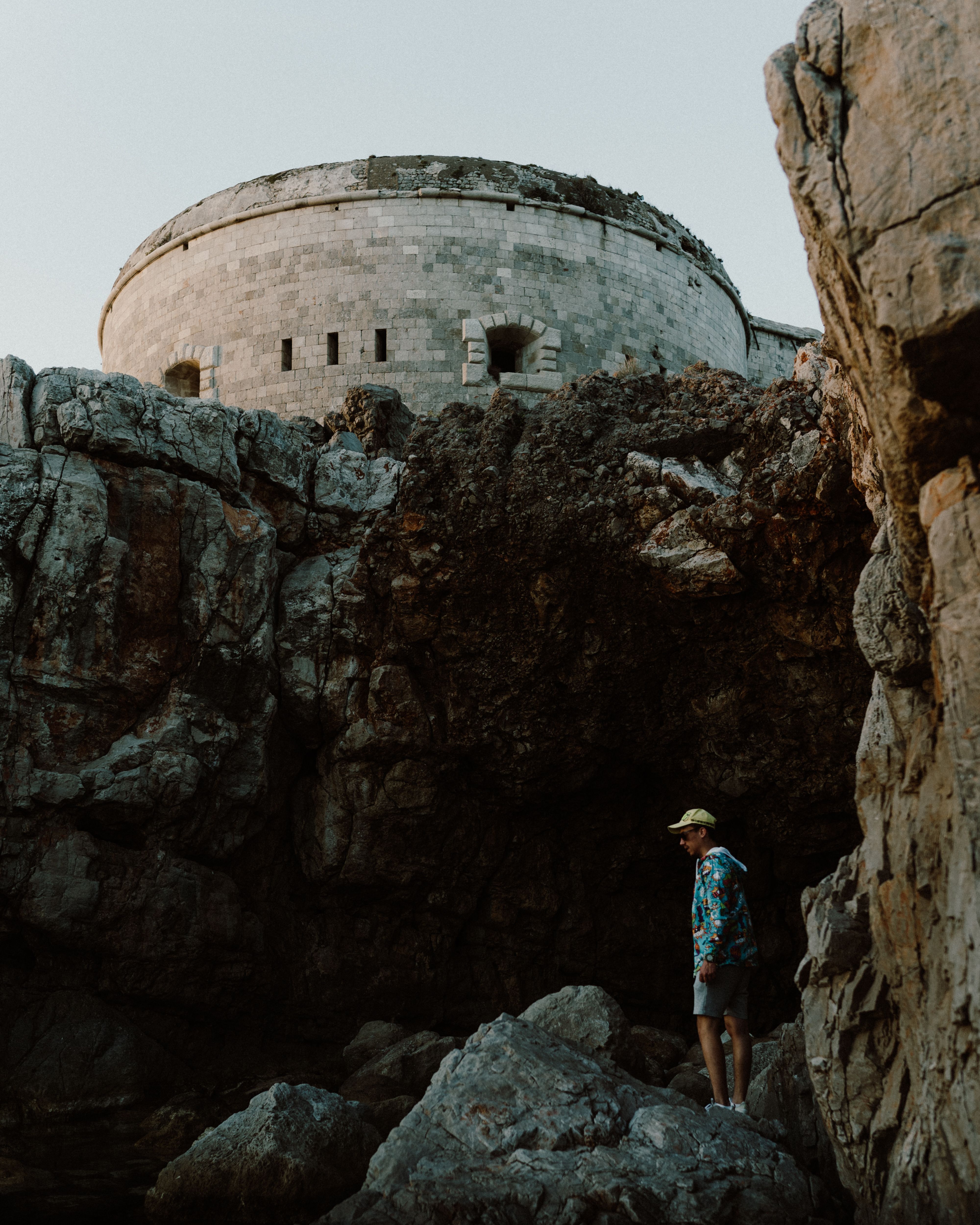 Man Standing on Cliff Near Fortress · Free Stock Photo