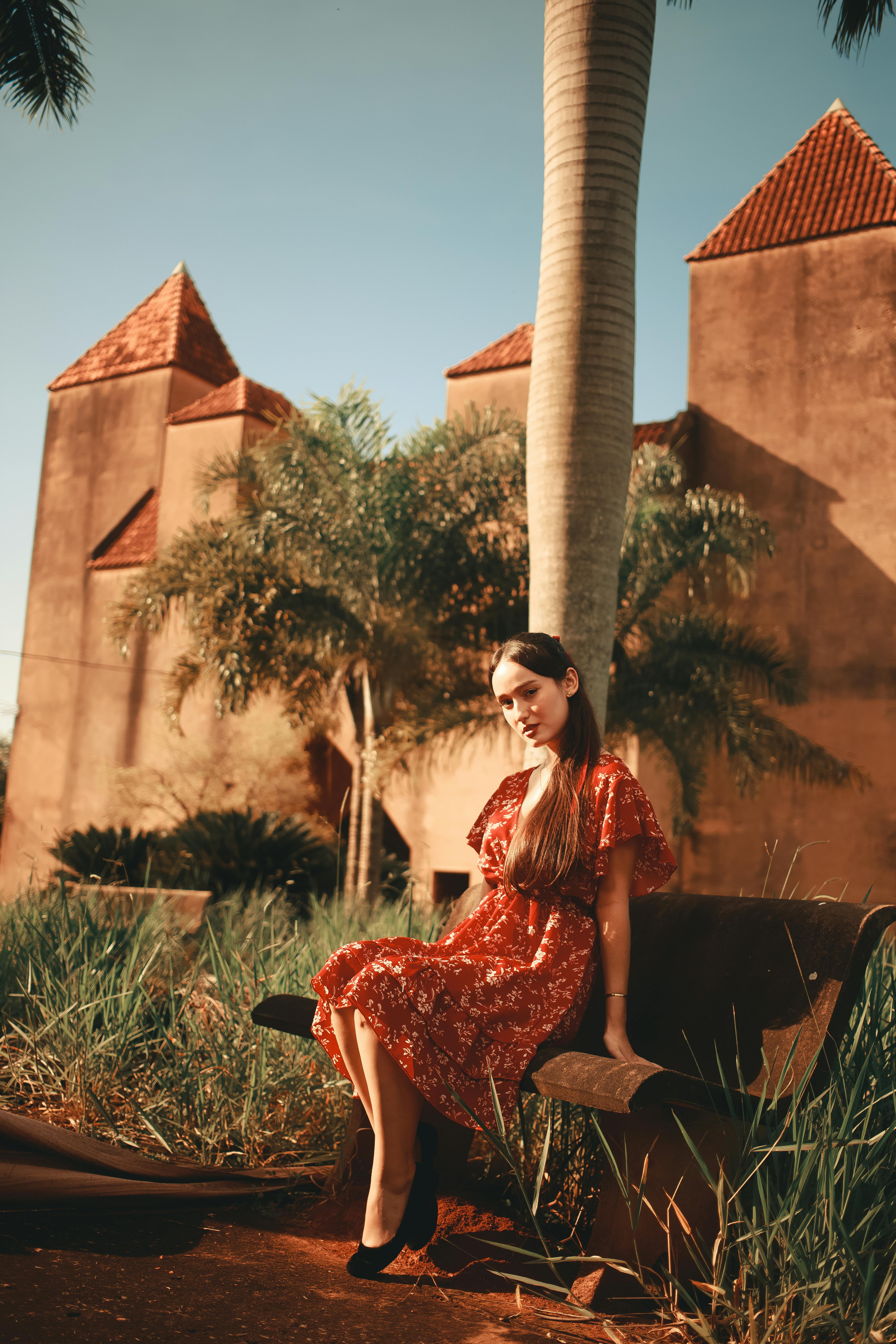 Woman in Red Dress Sitting on Bench in Park · Free Stock Photo