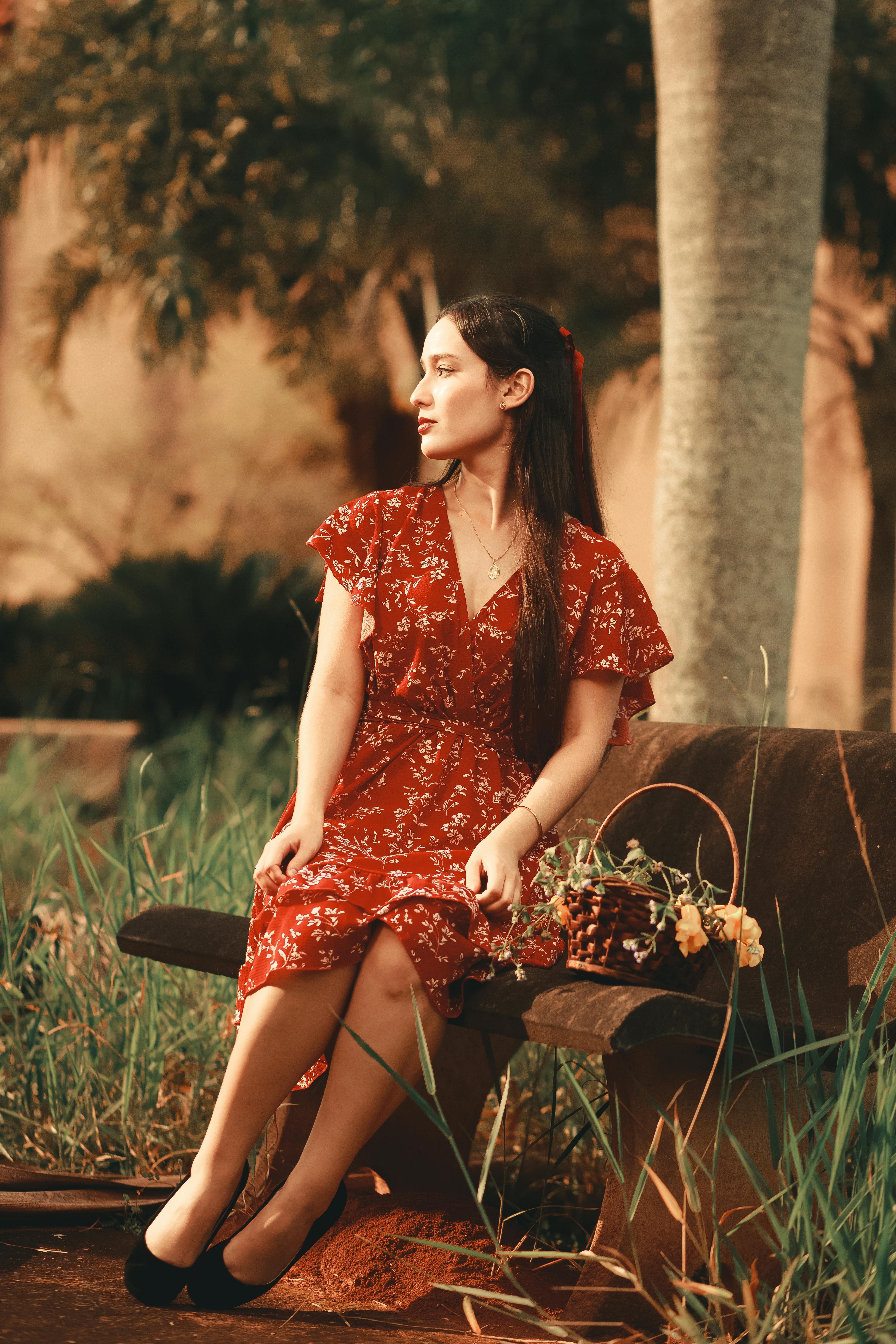 Brunette Woman in Red Dress Sitting on Bench · Free Stock Photo