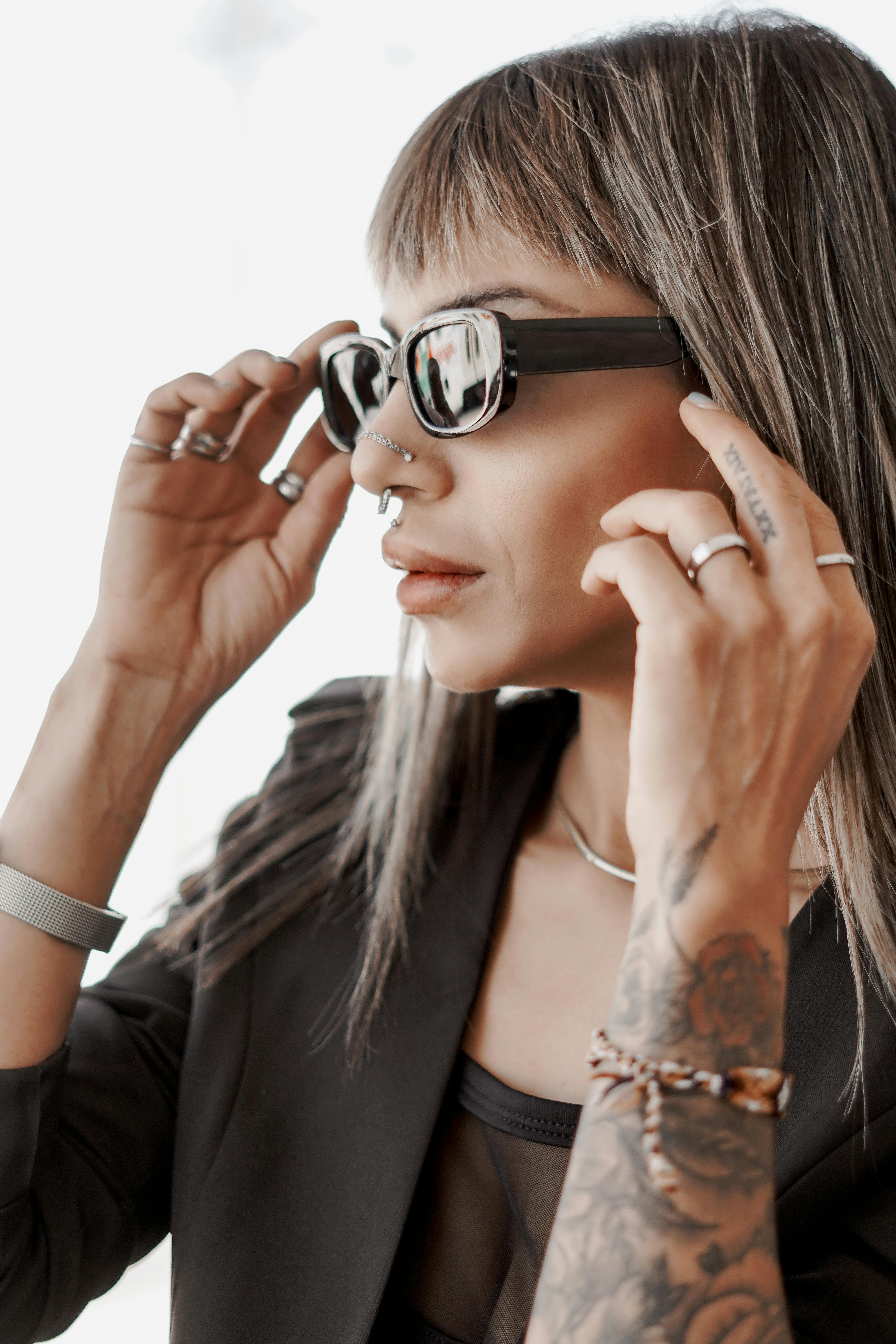 Woman with Piercings and Tattoos on her Forearm · Free Stock Photo