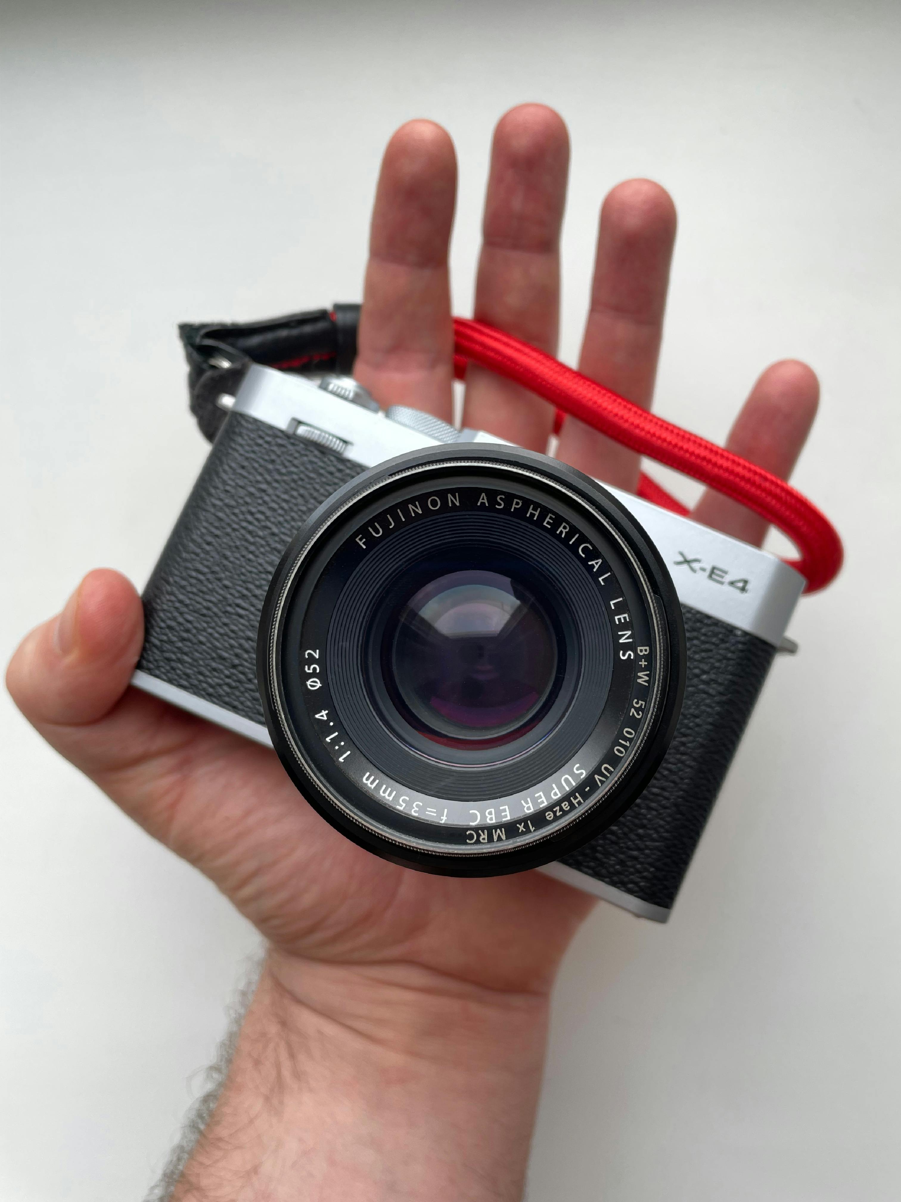 Fujifilm XE-4 camera in man's hand. Fuji lens. Stylish retro camera ...