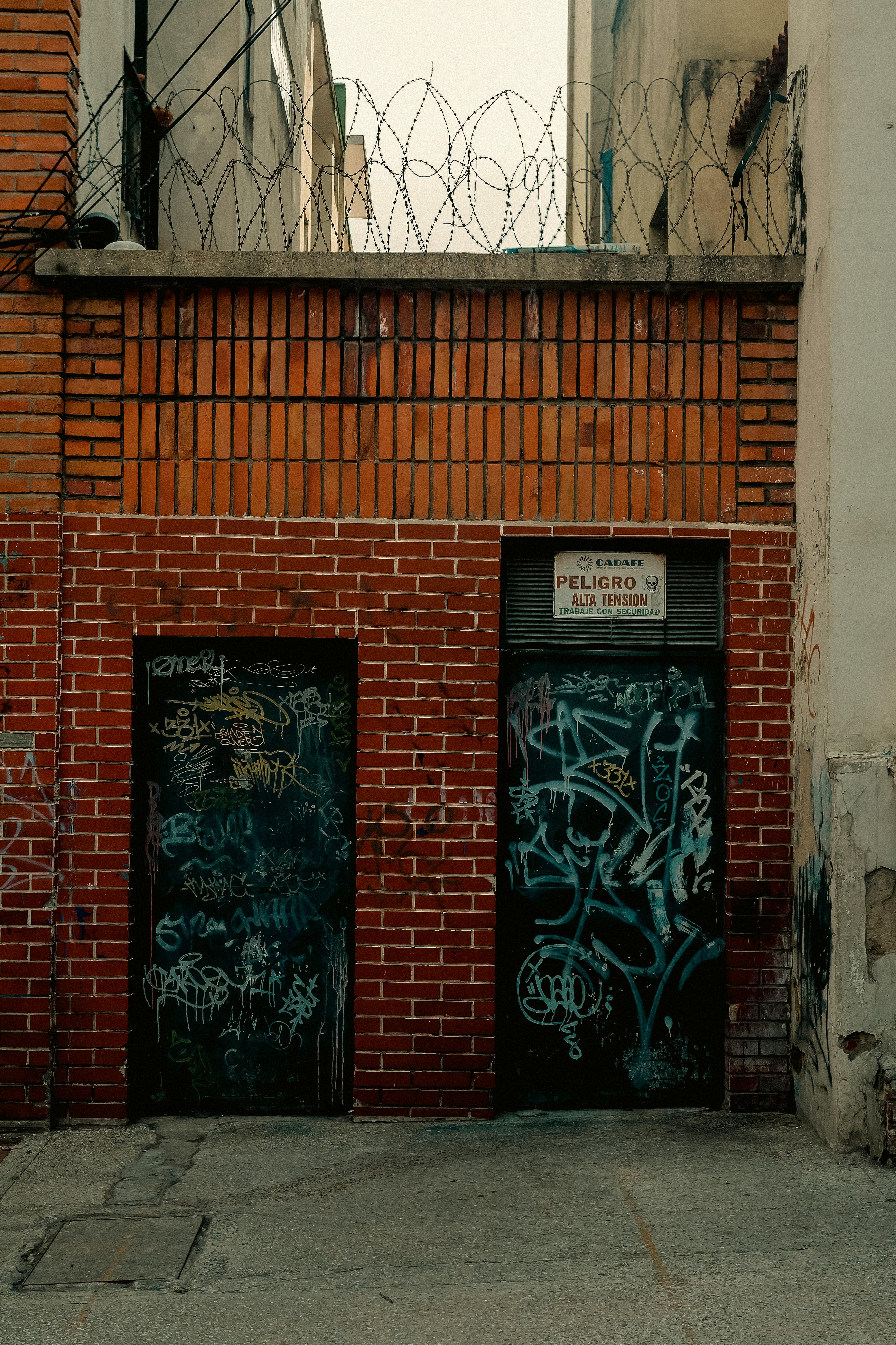 A door with graffiti on it and barbed wire · Free Stock Photo