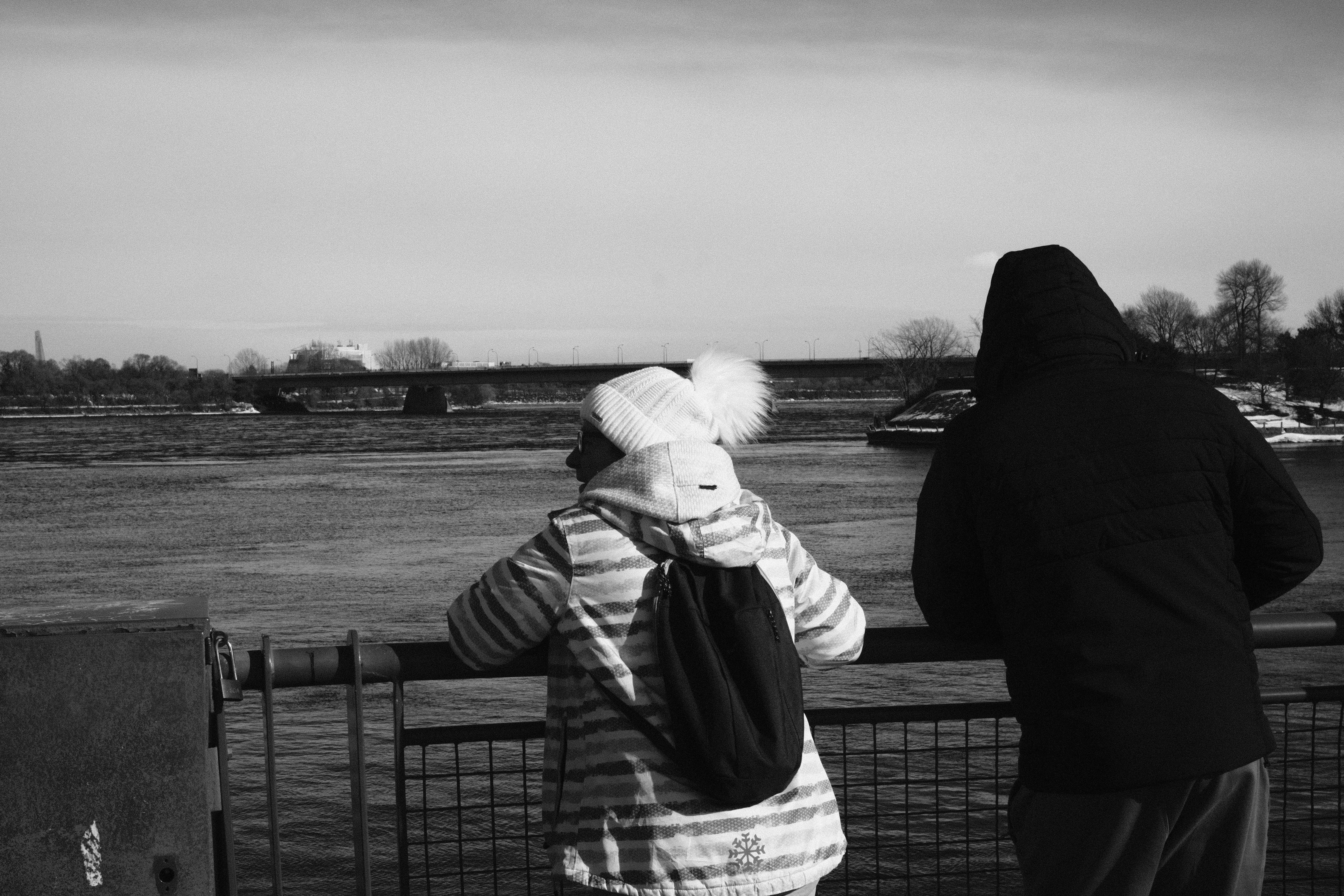 Back View of a Couple Leaning against the Railing by a River · Free ...