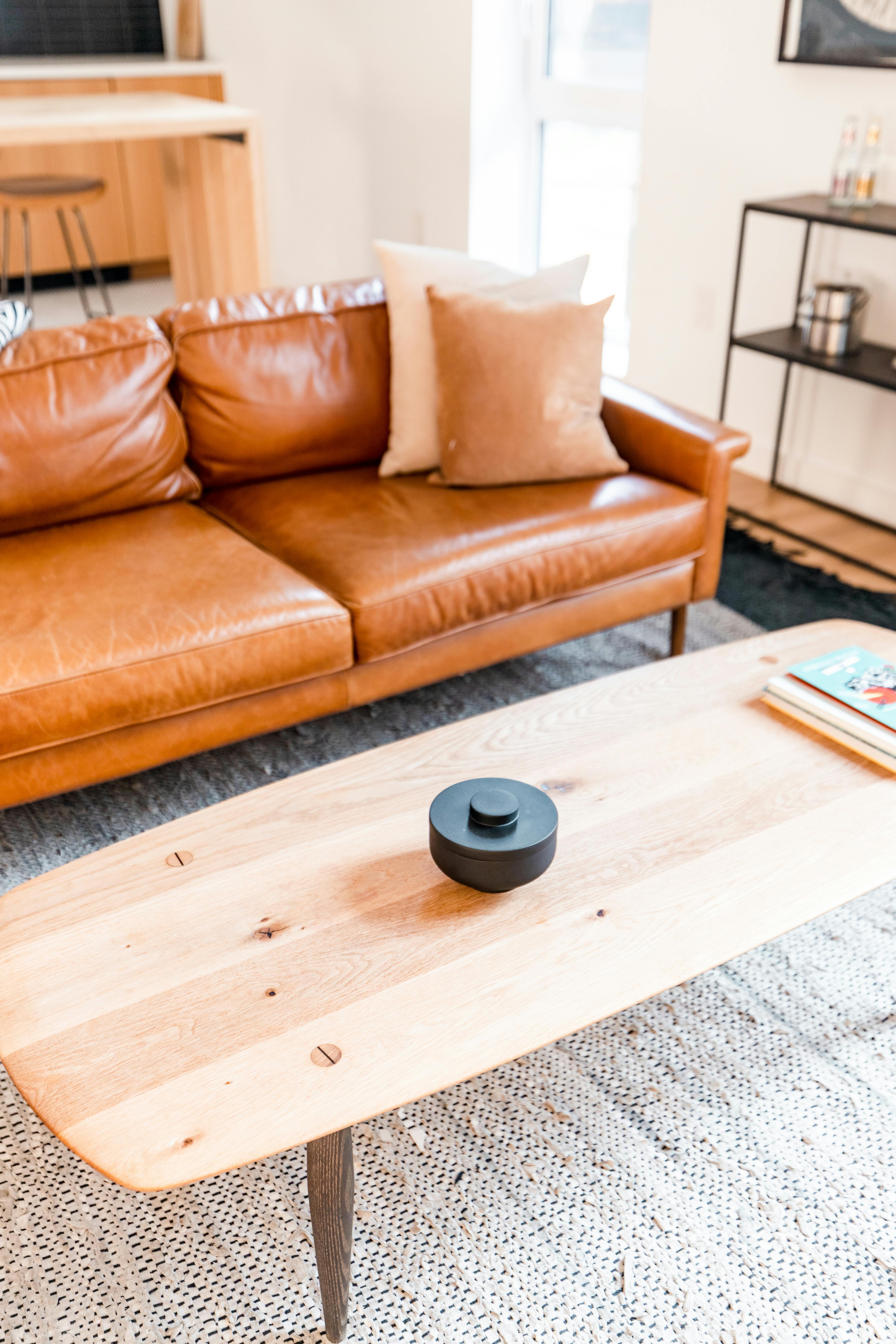 Photo Of Table Near Grey Couch · Free Stock Photo