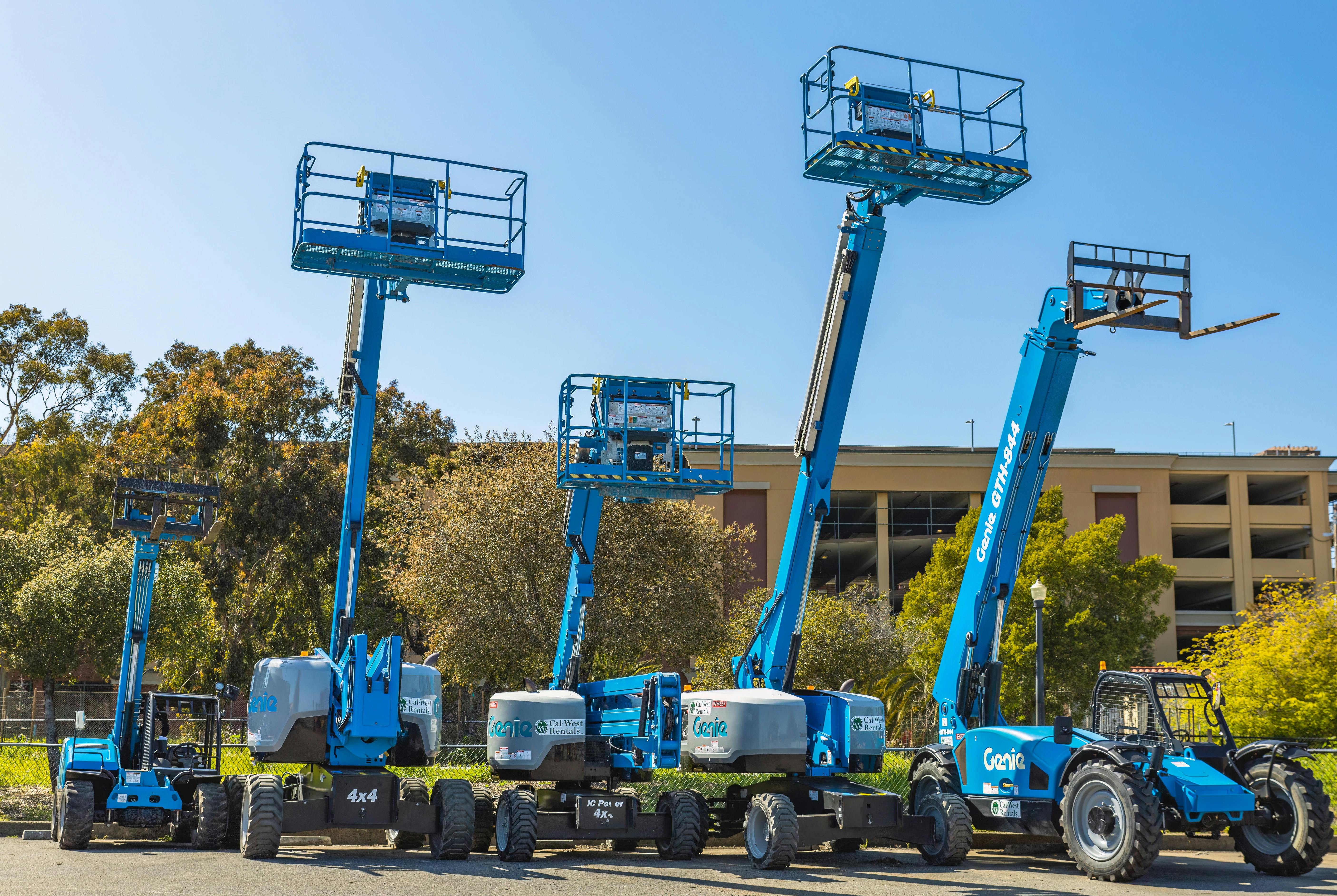 Blue Aerial Lift and Forklift Trucks · Free Stock Photo