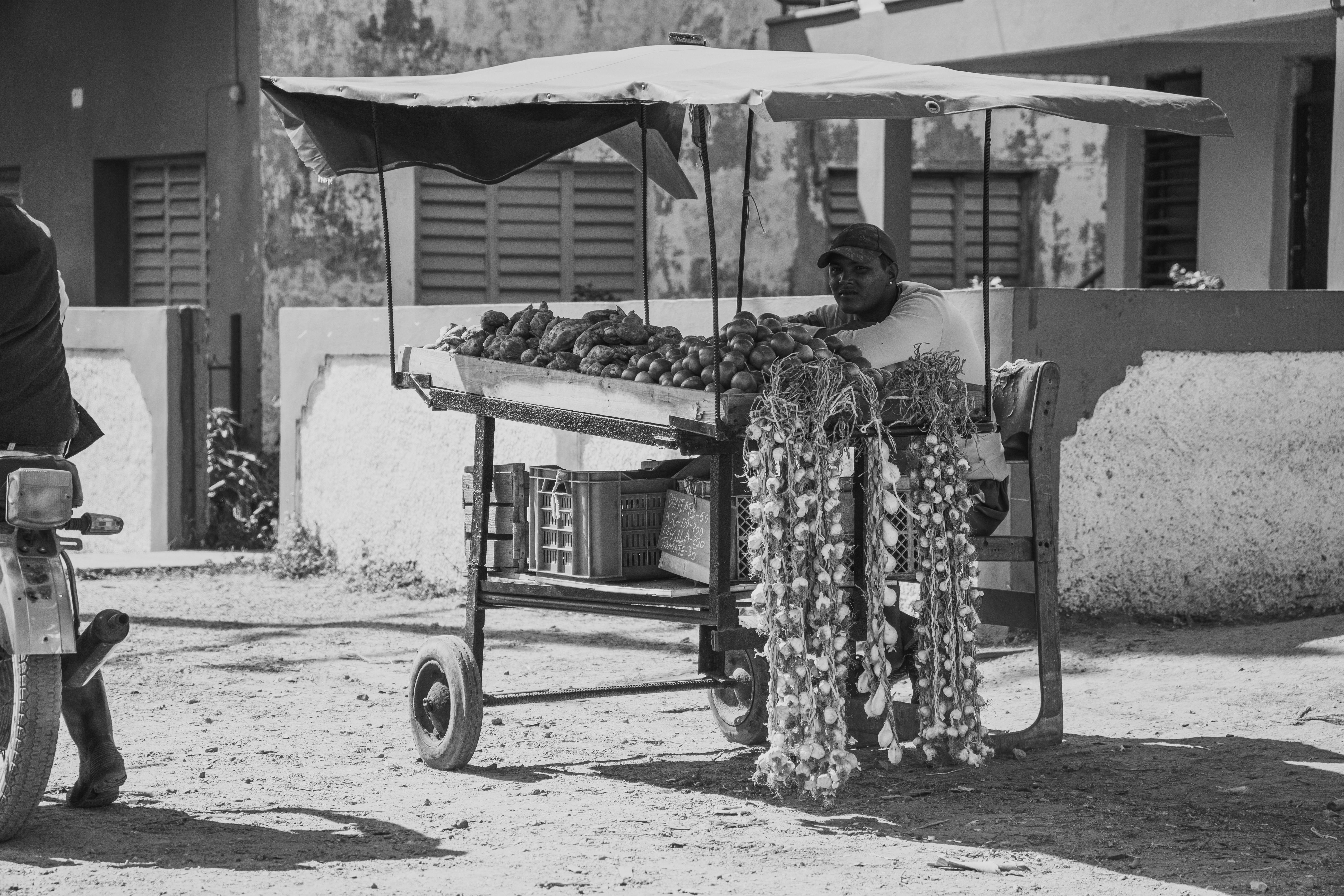 Man Selling at a Market Stand · Free Stock Photo
