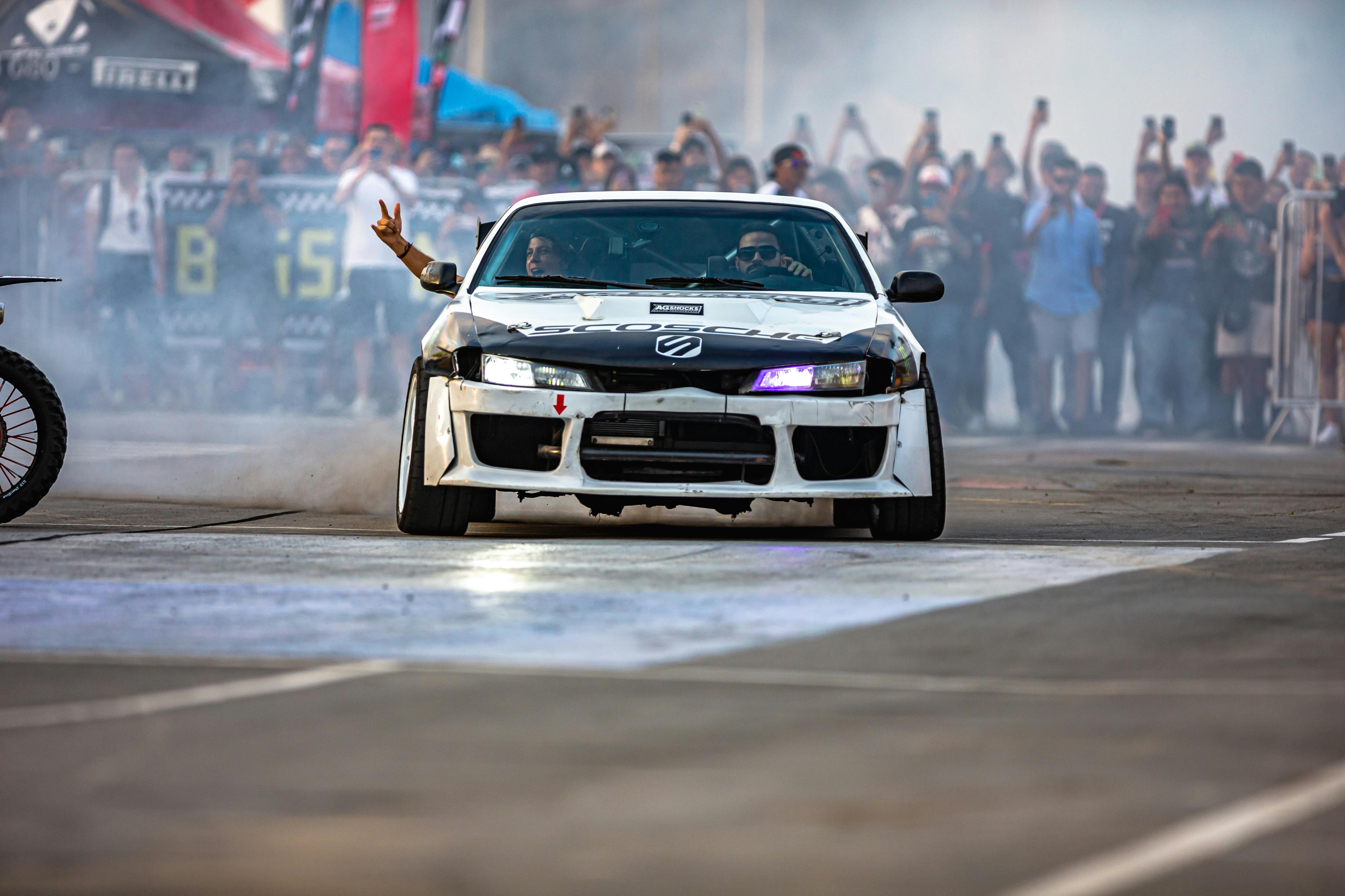 People Driving a Car in a Race · Free Stock Photo