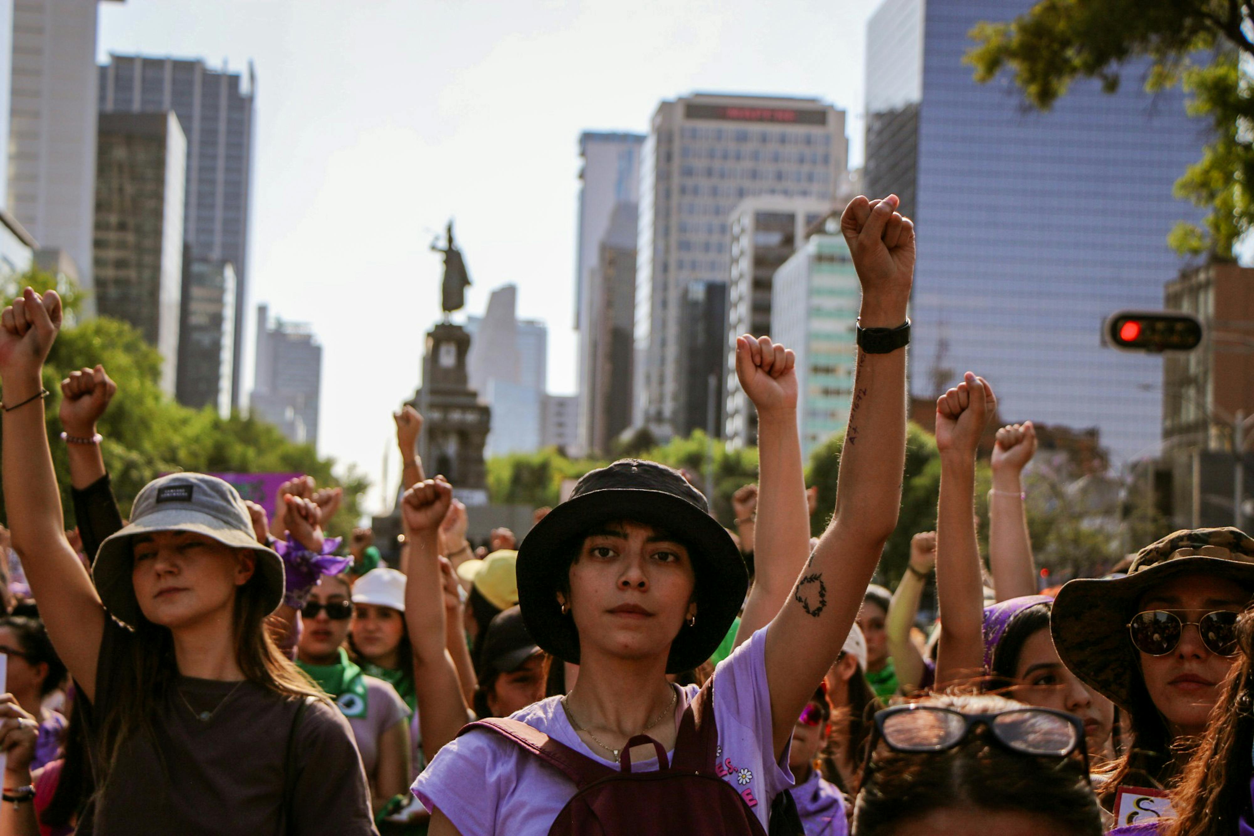 Women Raising Fists During March in Downtown · Free Stock Photo