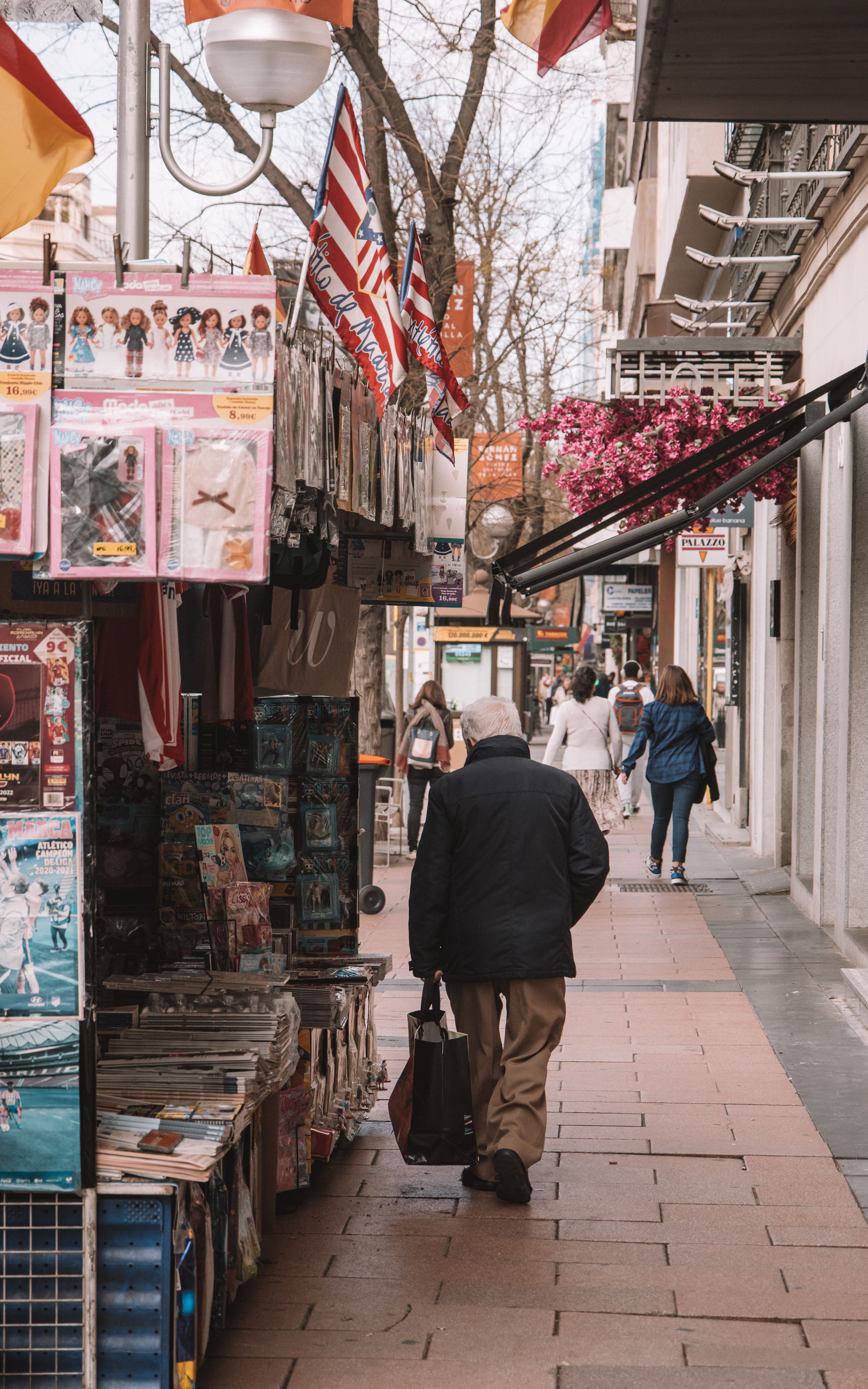 Elderly Man Walking by Booth on Sidewalk · Free Stock Photo