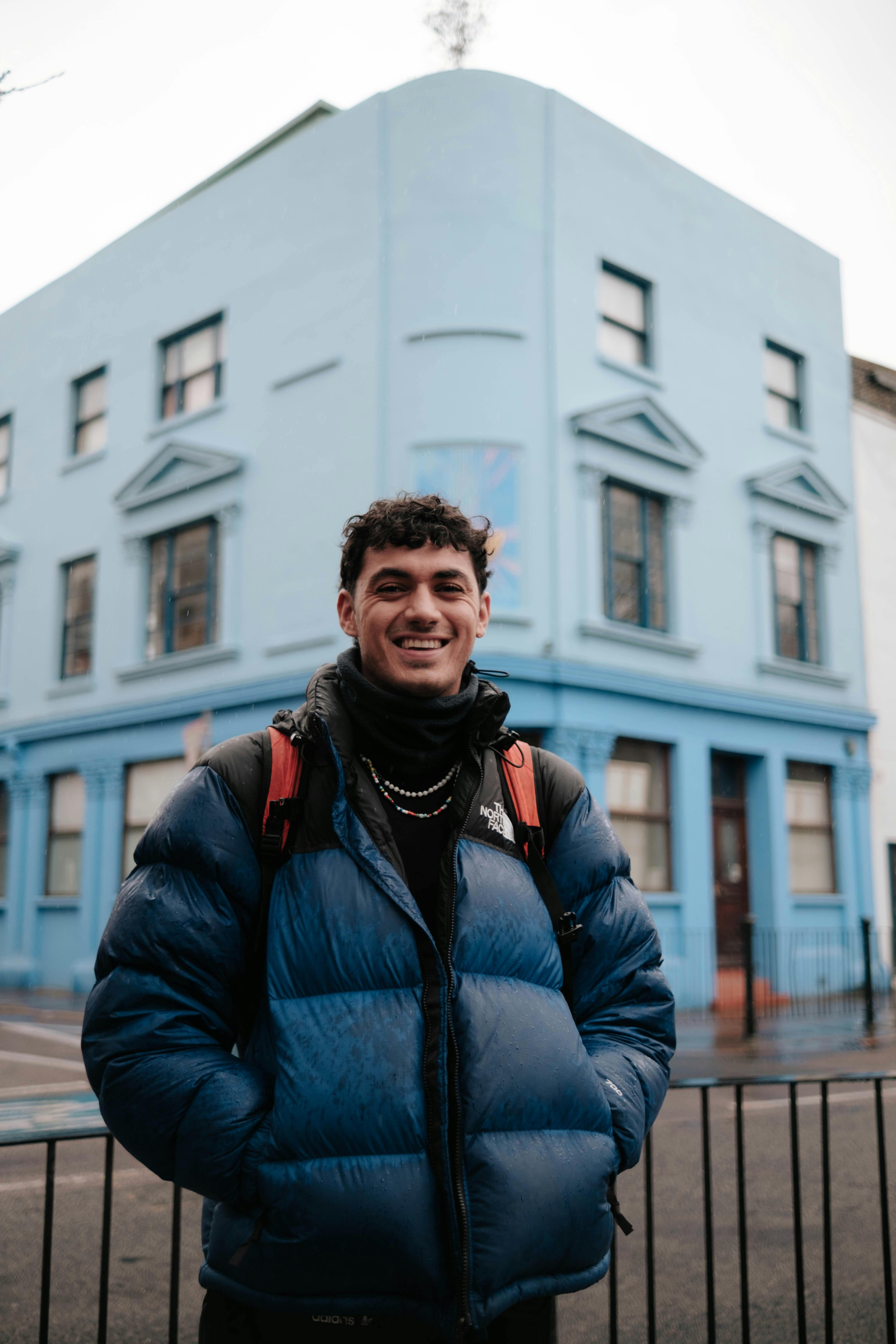 Smiling Man Standing on a City Street · Free Stock Photo