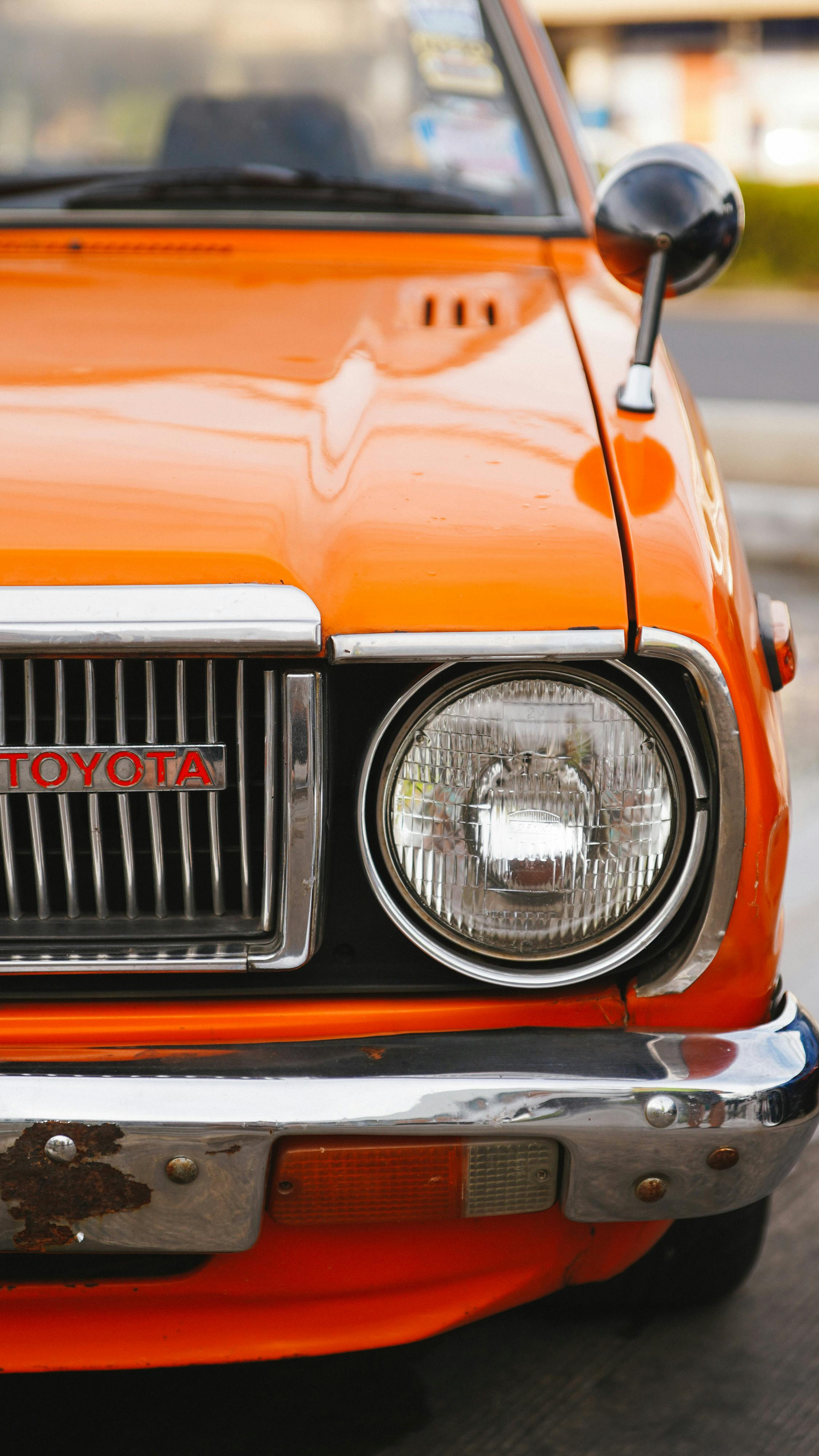 Front of a Classic Orange Toyota Corolla E30 · Free Stock Photo