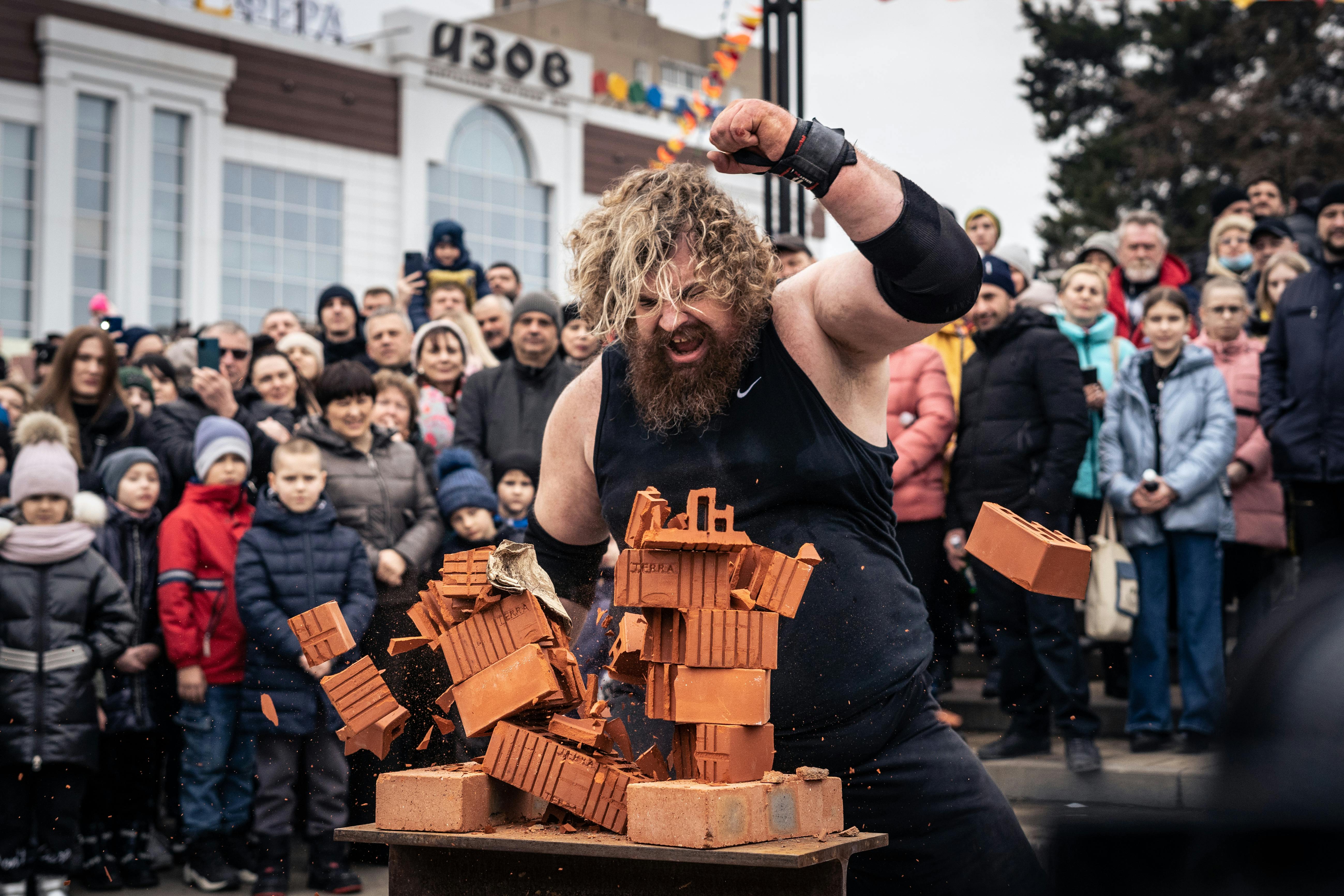 Black and White Photo of Strongman Smashing Bricks · Free Stock Photo