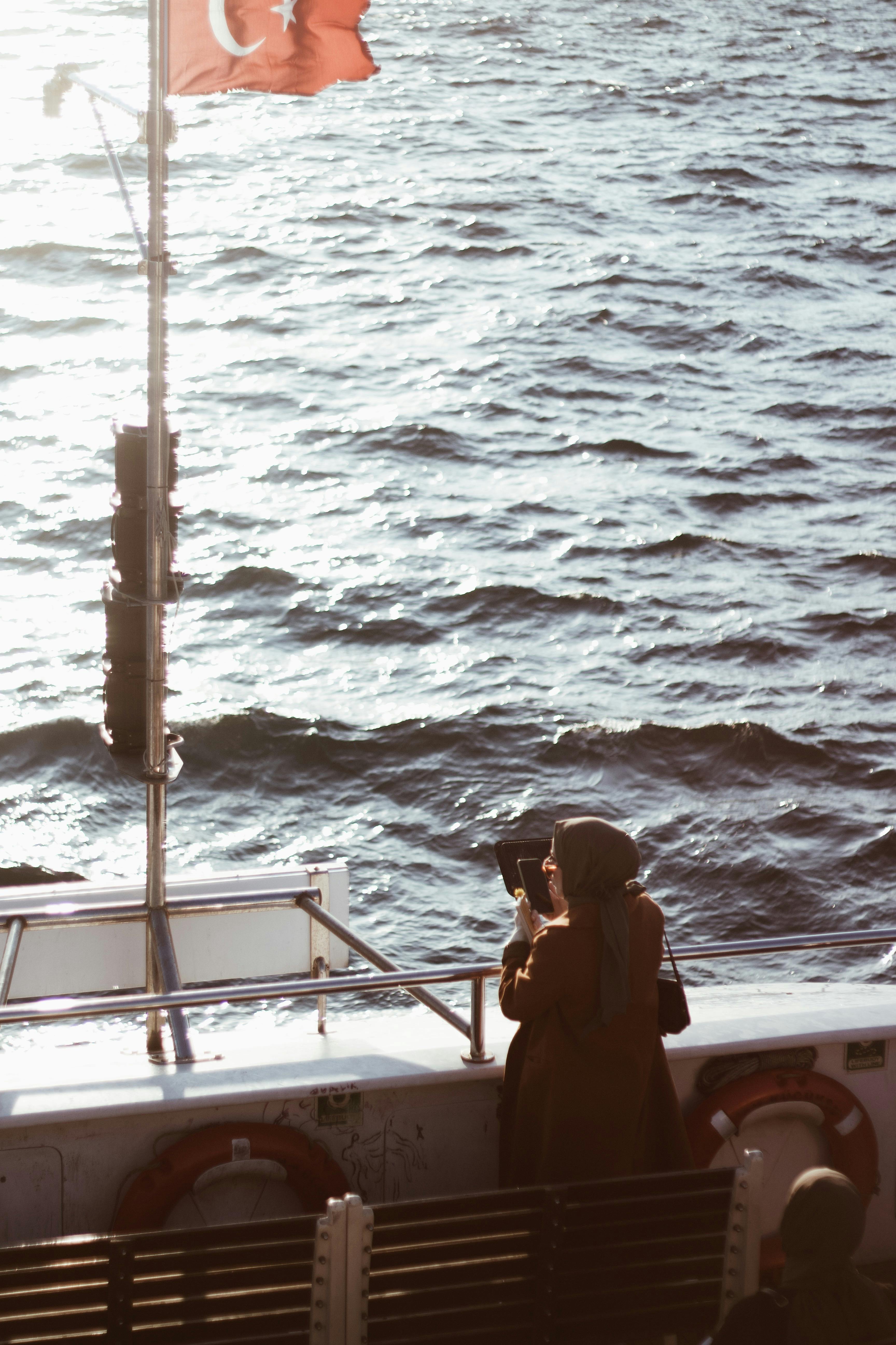 Woman Standing on a Boat · Free Stock Photo