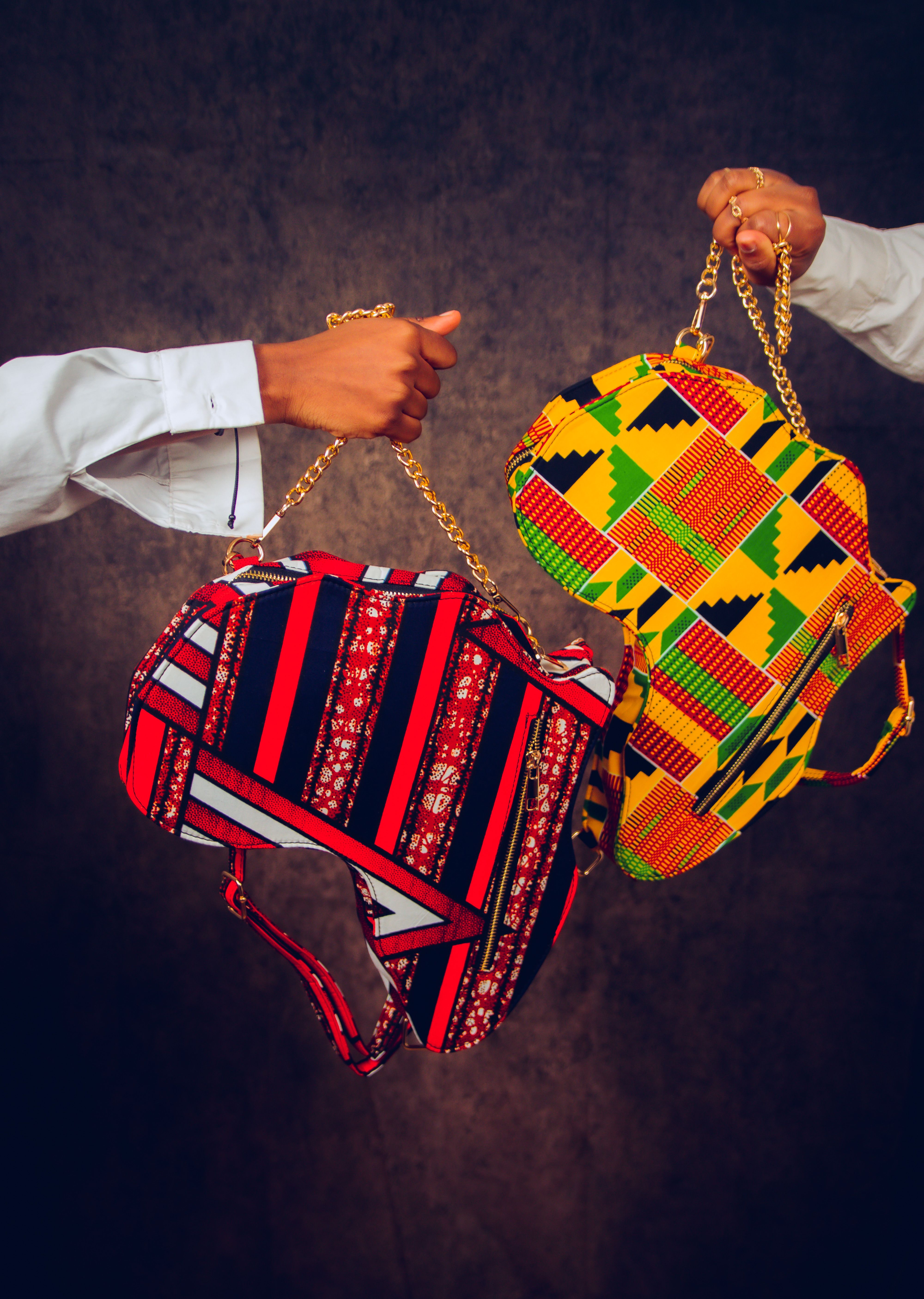 Hands Presenting Handbags in Shape of Africa Decorated with Traditional ...