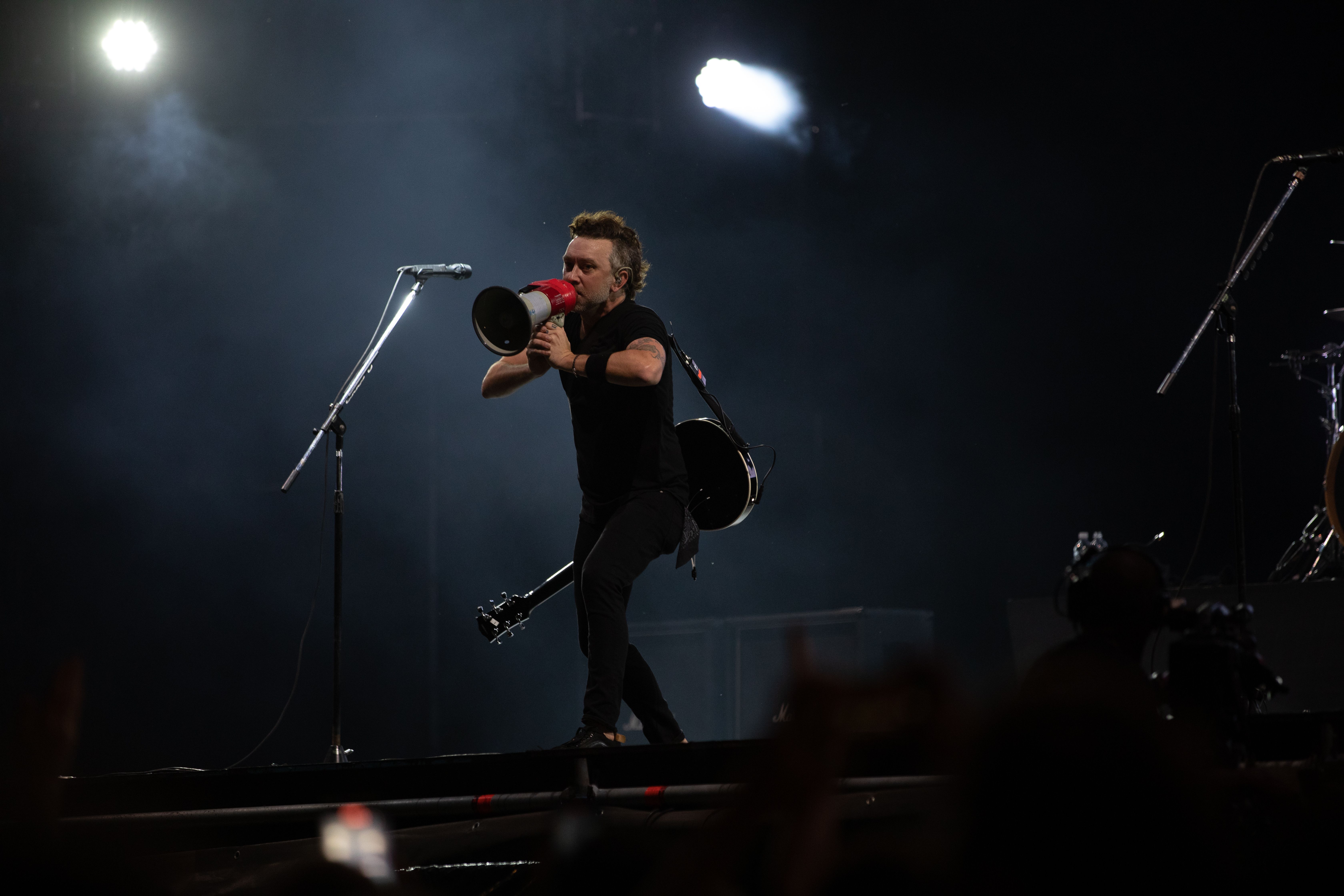 Singer with a Guitar on His Back Singing Through a Megaphone · Free ...