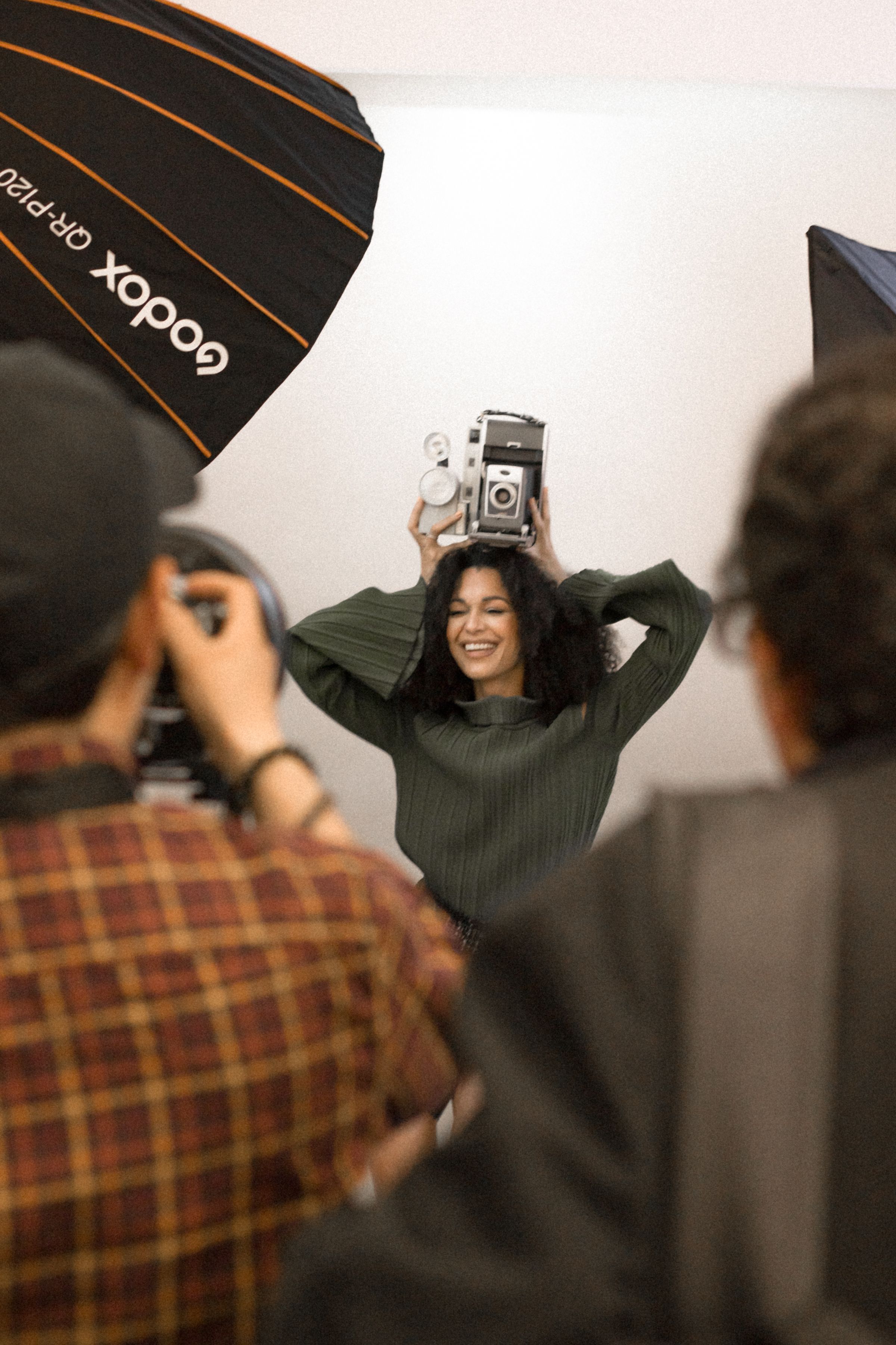 Man Photographing Smiling Model in Studio · Free Stock Photo