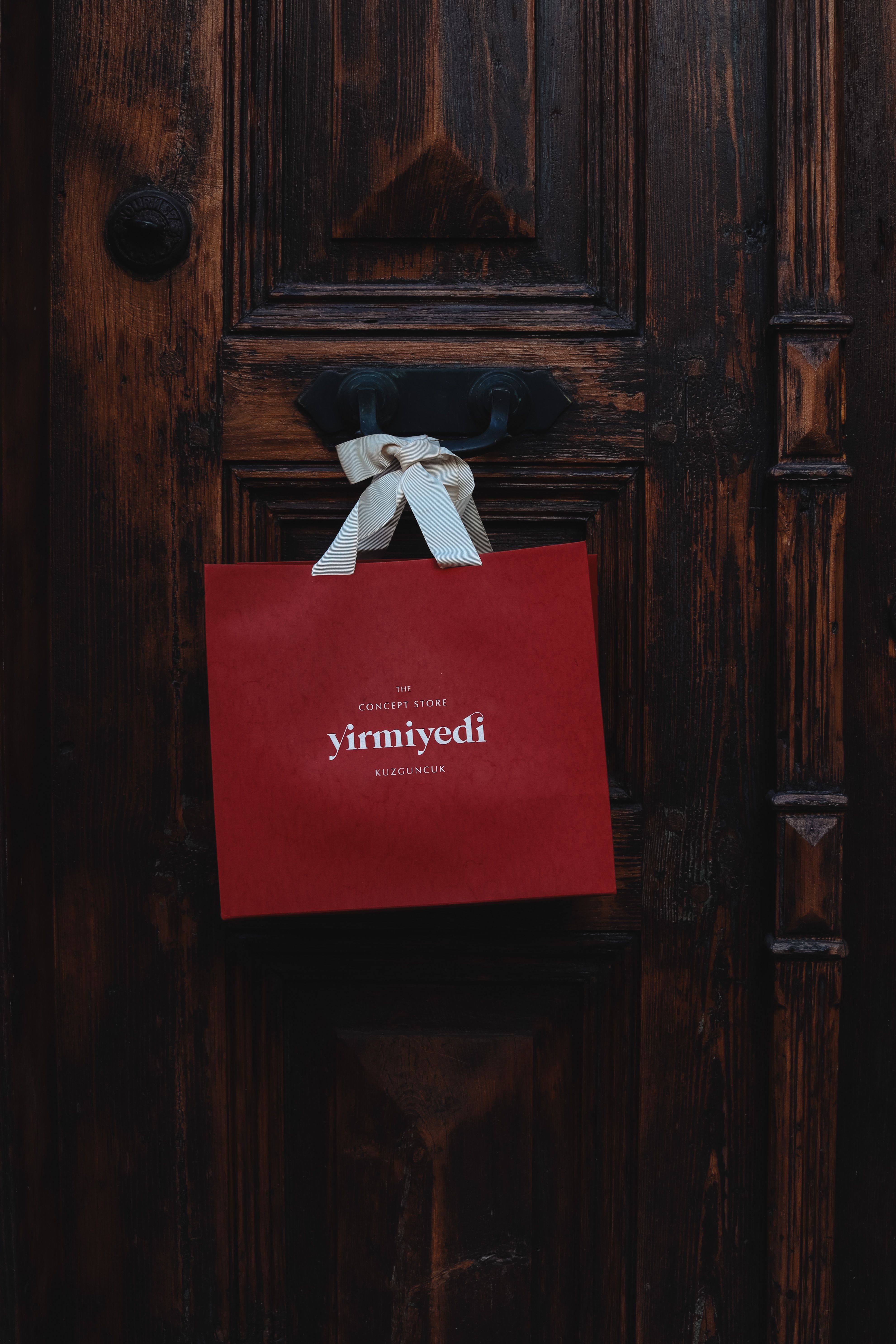 Close-up of a Gift Bag Hanging on Wooden Door · Free Stock Photo