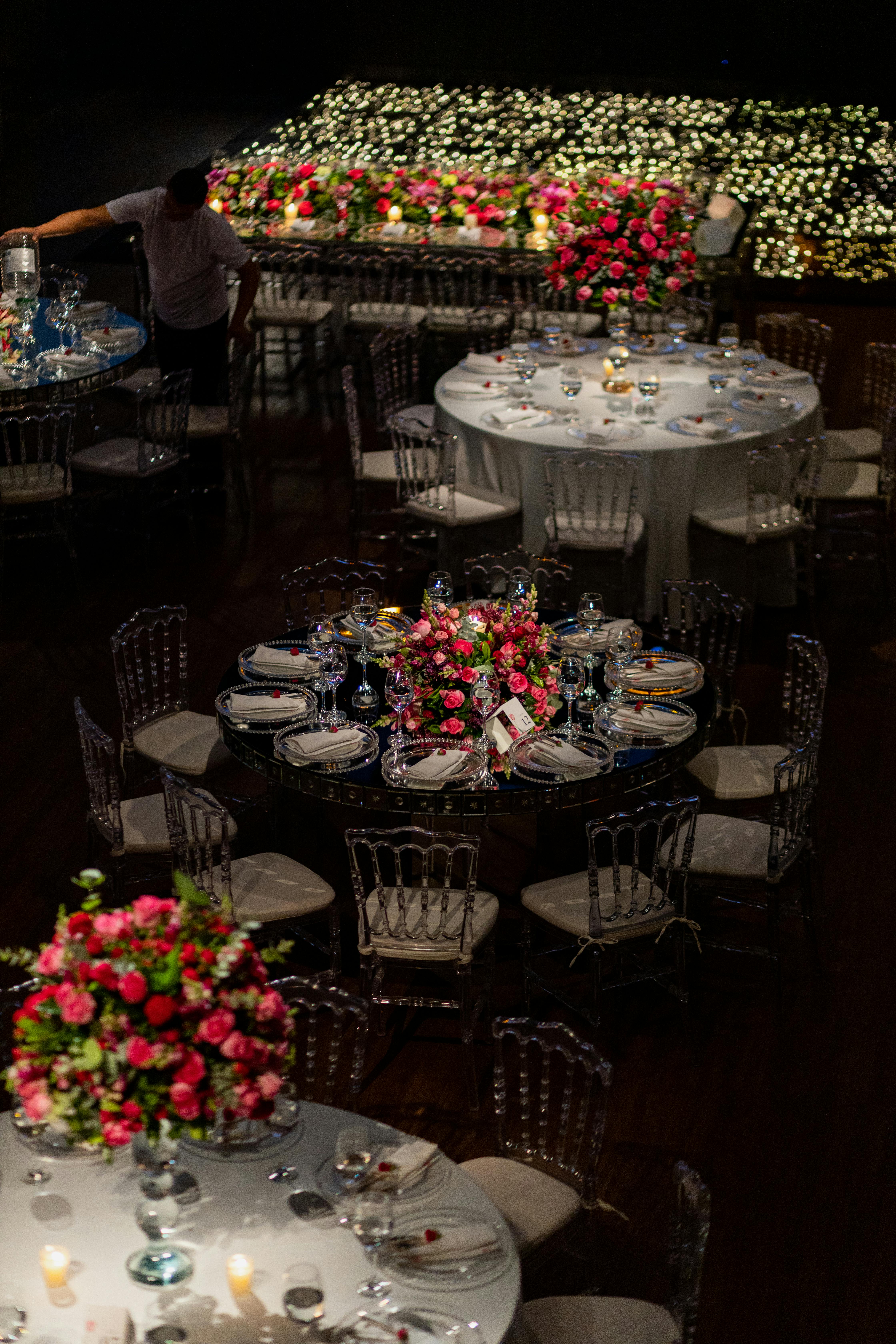 Elegant Banquet Setup with Round Tables and Pink Flower Arrangements ...