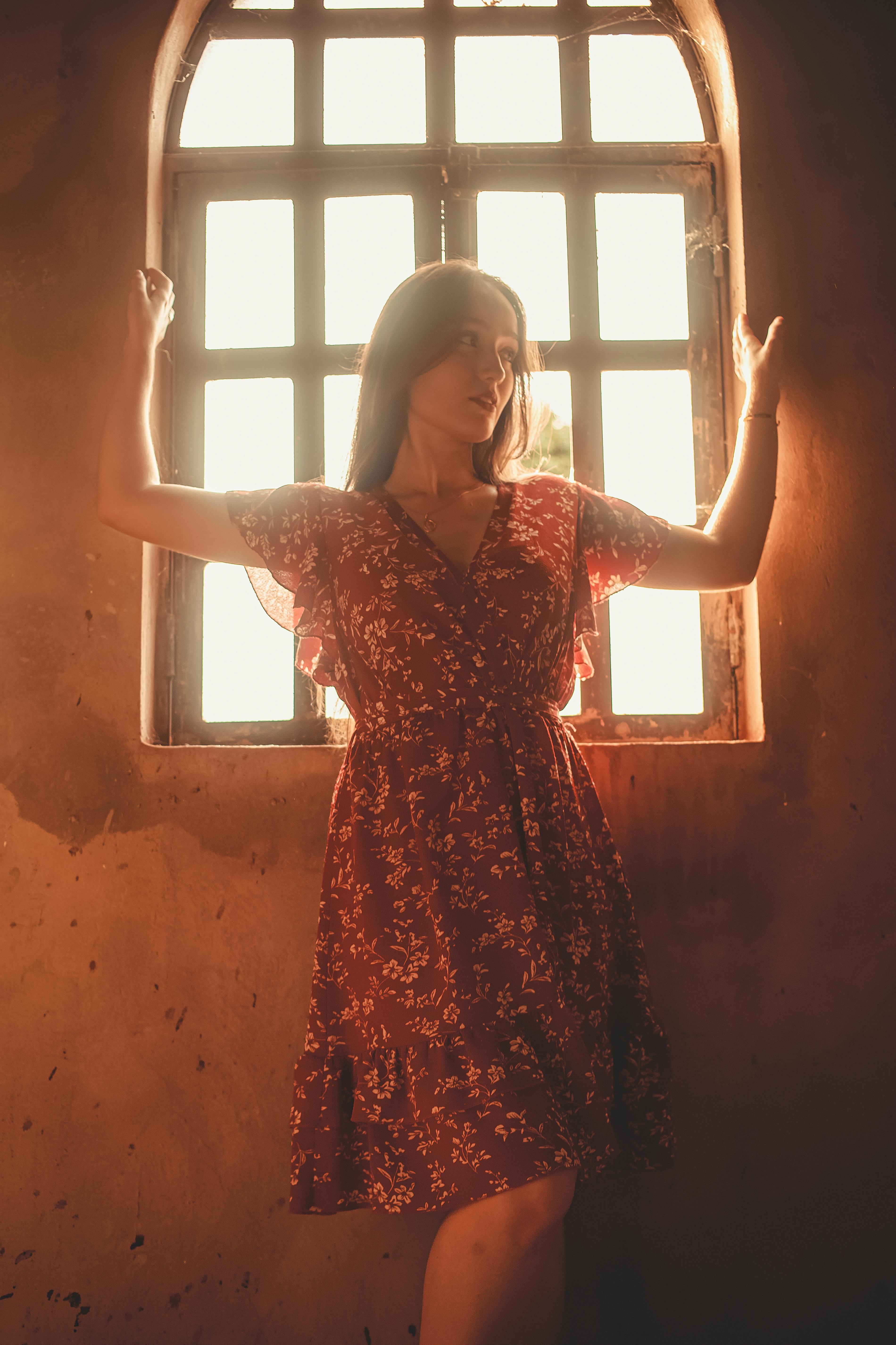 Woman Standing in Window · Free Stock Photo