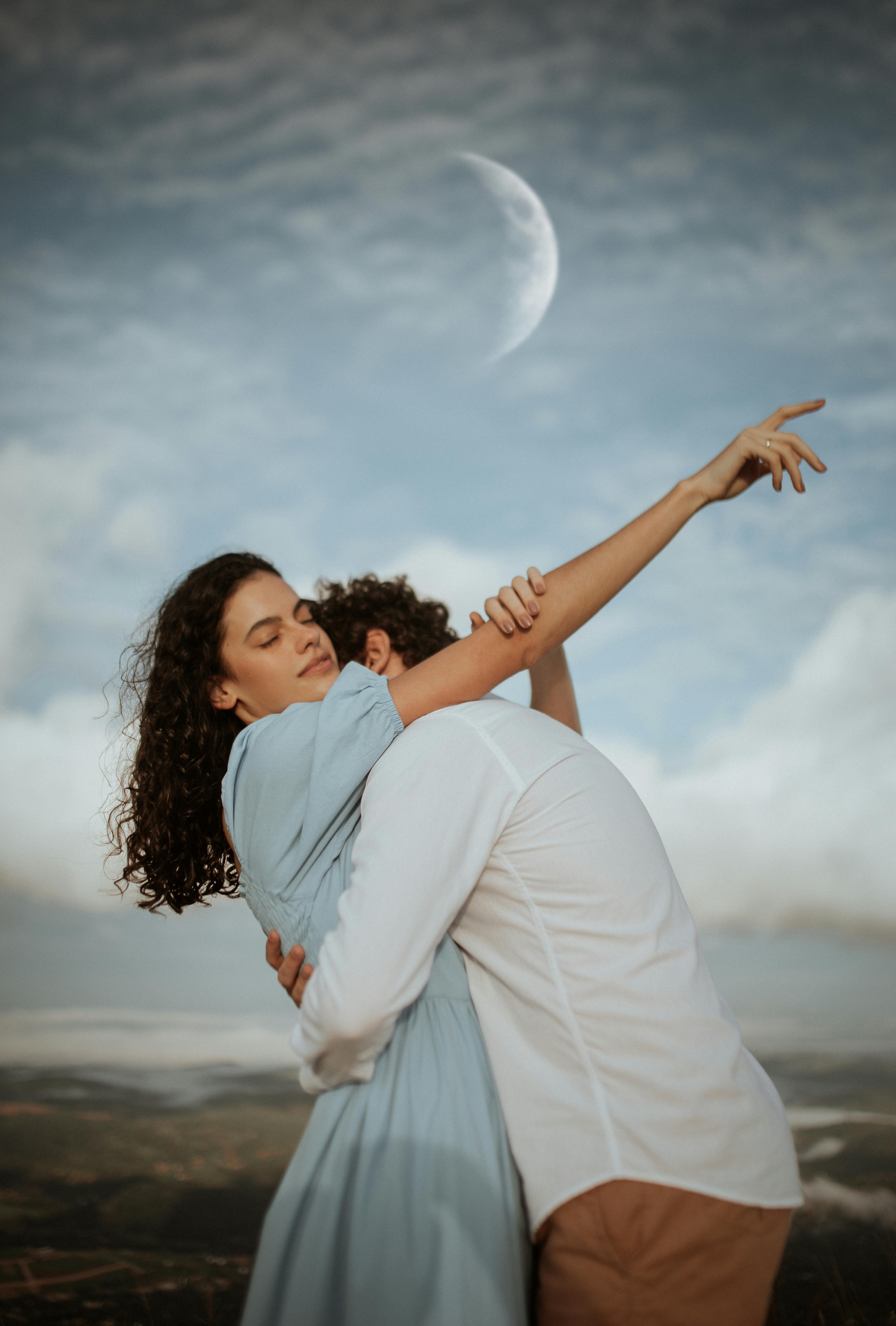 Moon Rising over an Embracing Couple · Free Stock Photo
