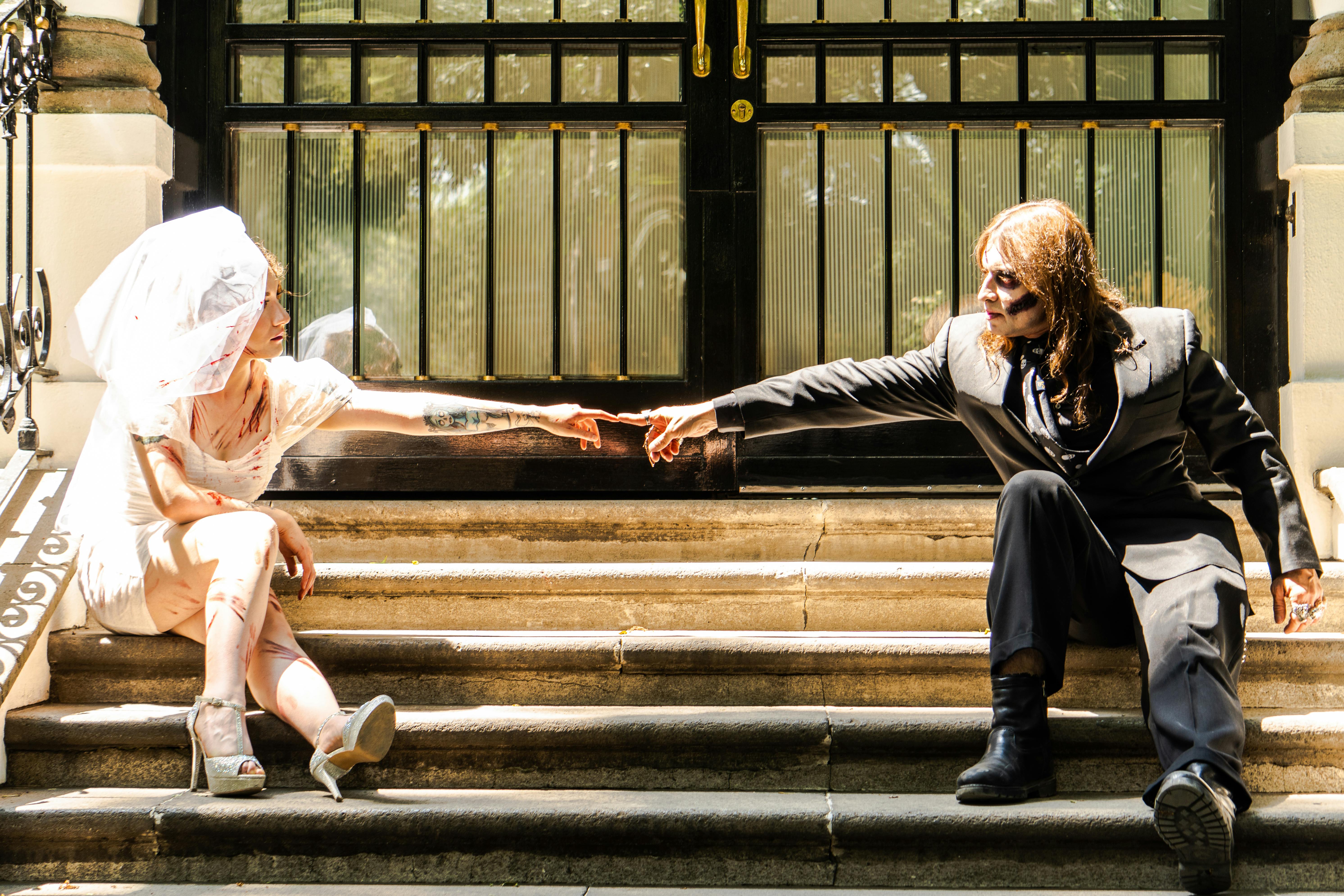 Spooky Bride and Groom Sitting on Stairs · Free Stock Photo