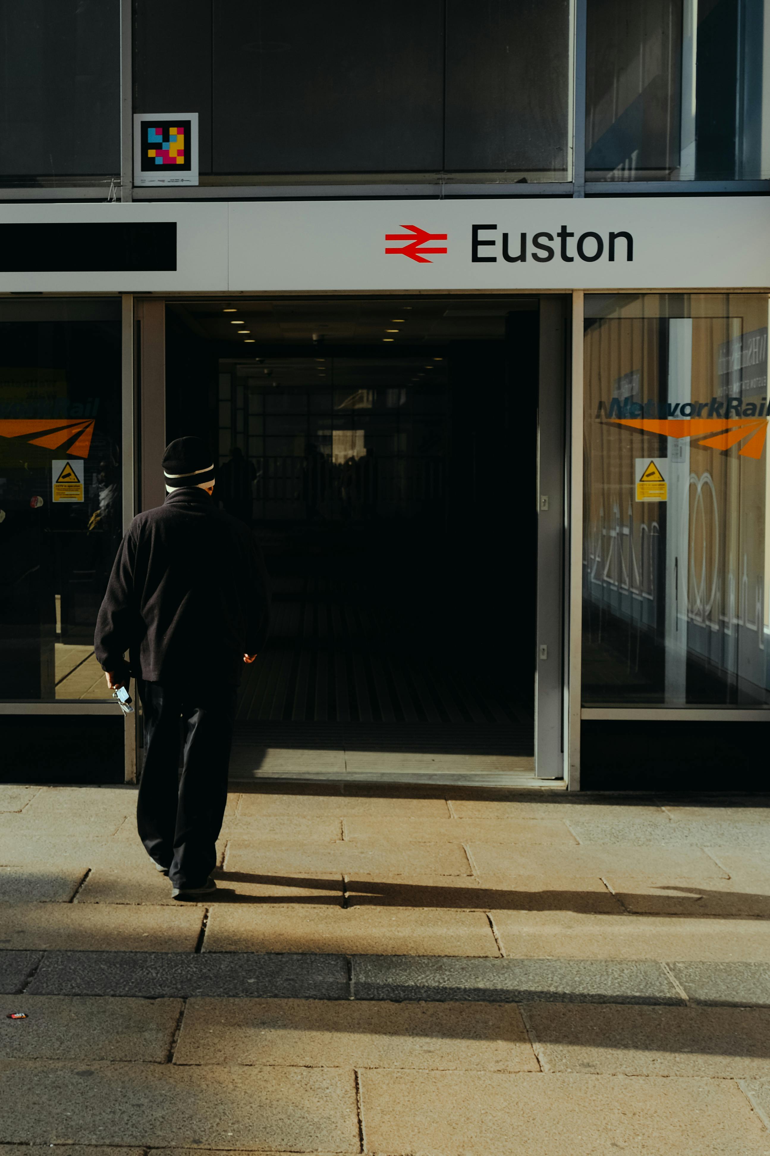 Man Walking Towards Euston Station Entrance · Free Stock Photo