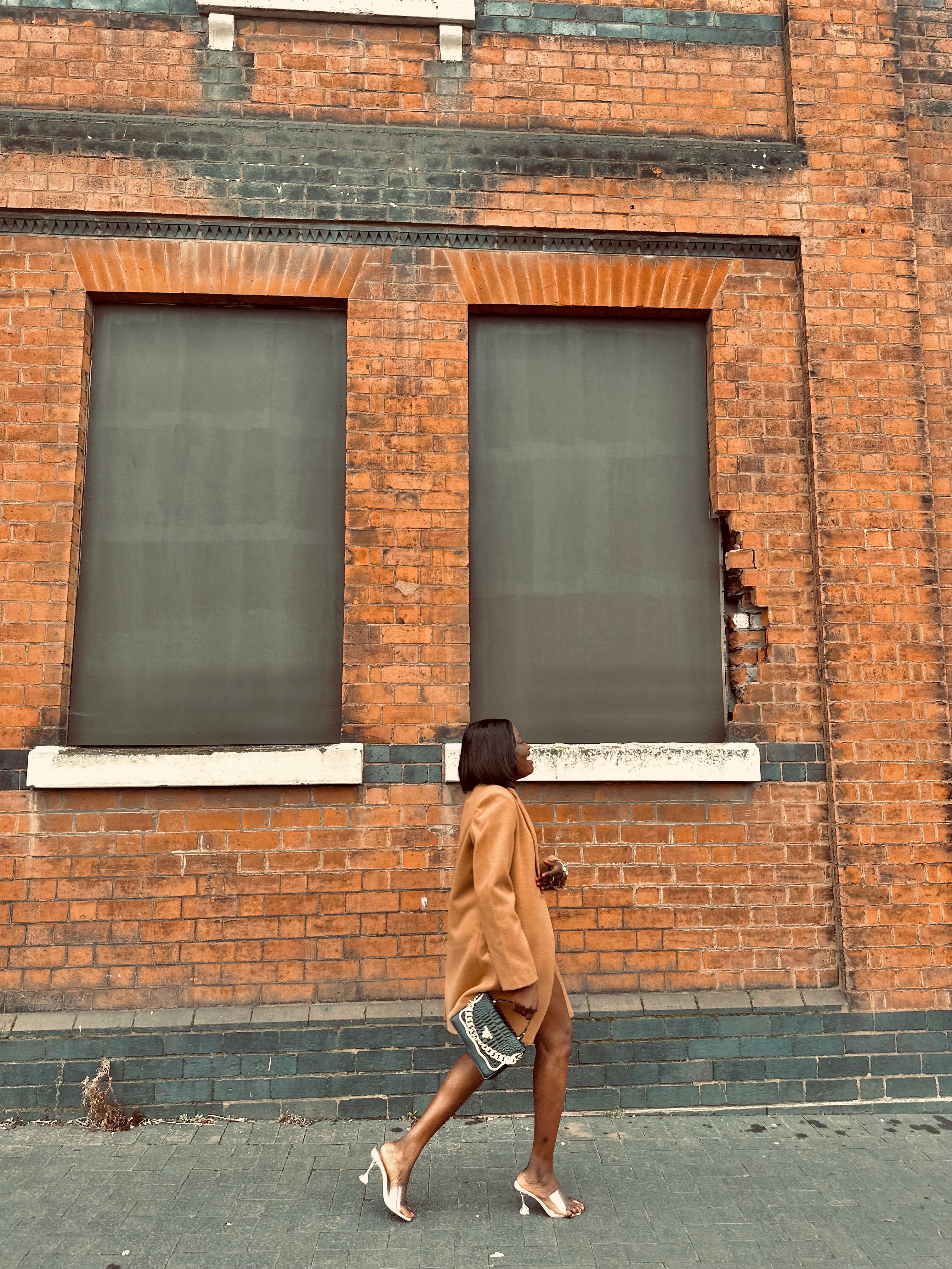 Elegant Woman in Heels Walking on a Sidewalk by a Building in City ...