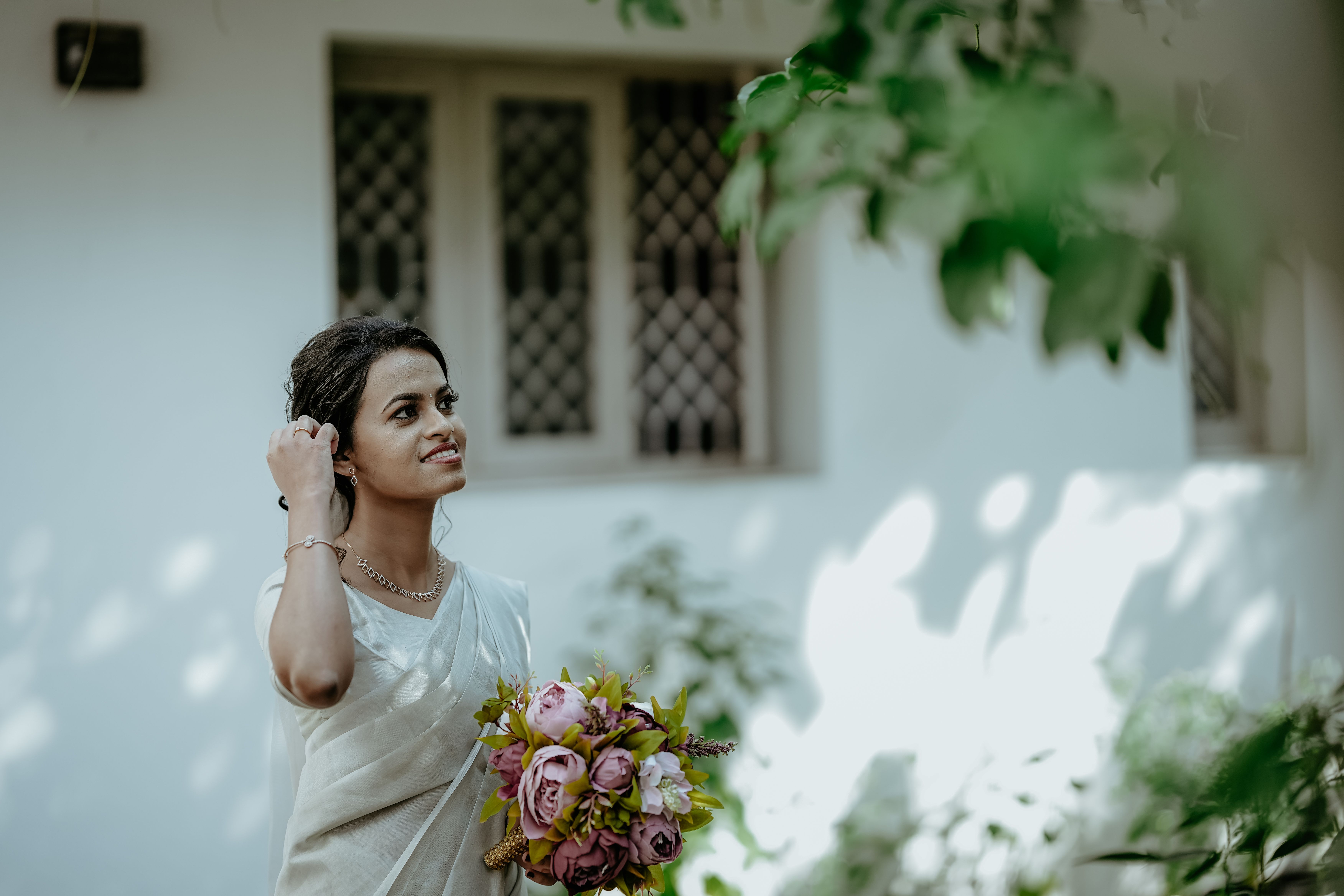 Smiling Bride Standing in Thoughtful Pose in Park or Garden · Free ...