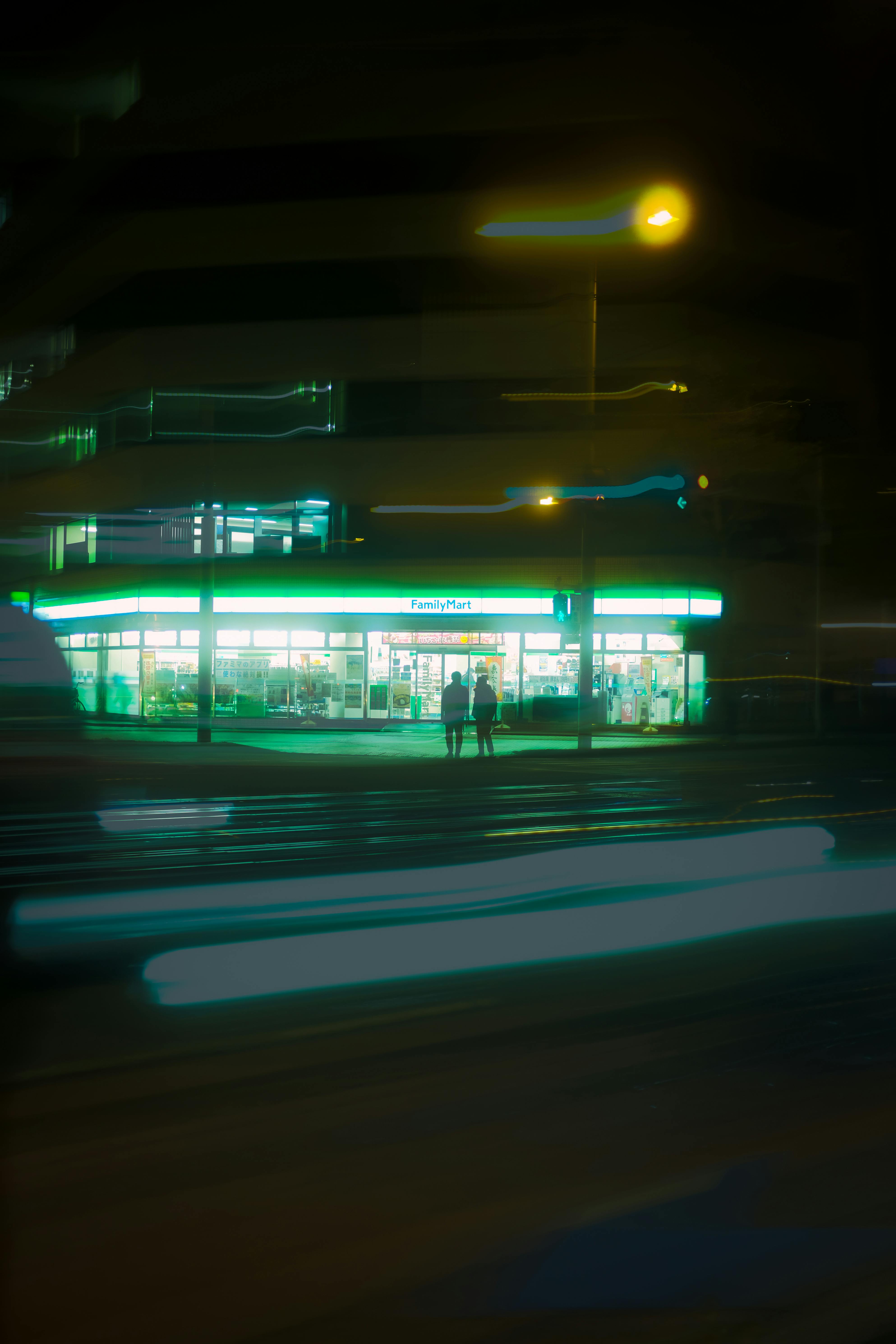 Illuminated Store near the Street in City at Night · Free Stock Photo
