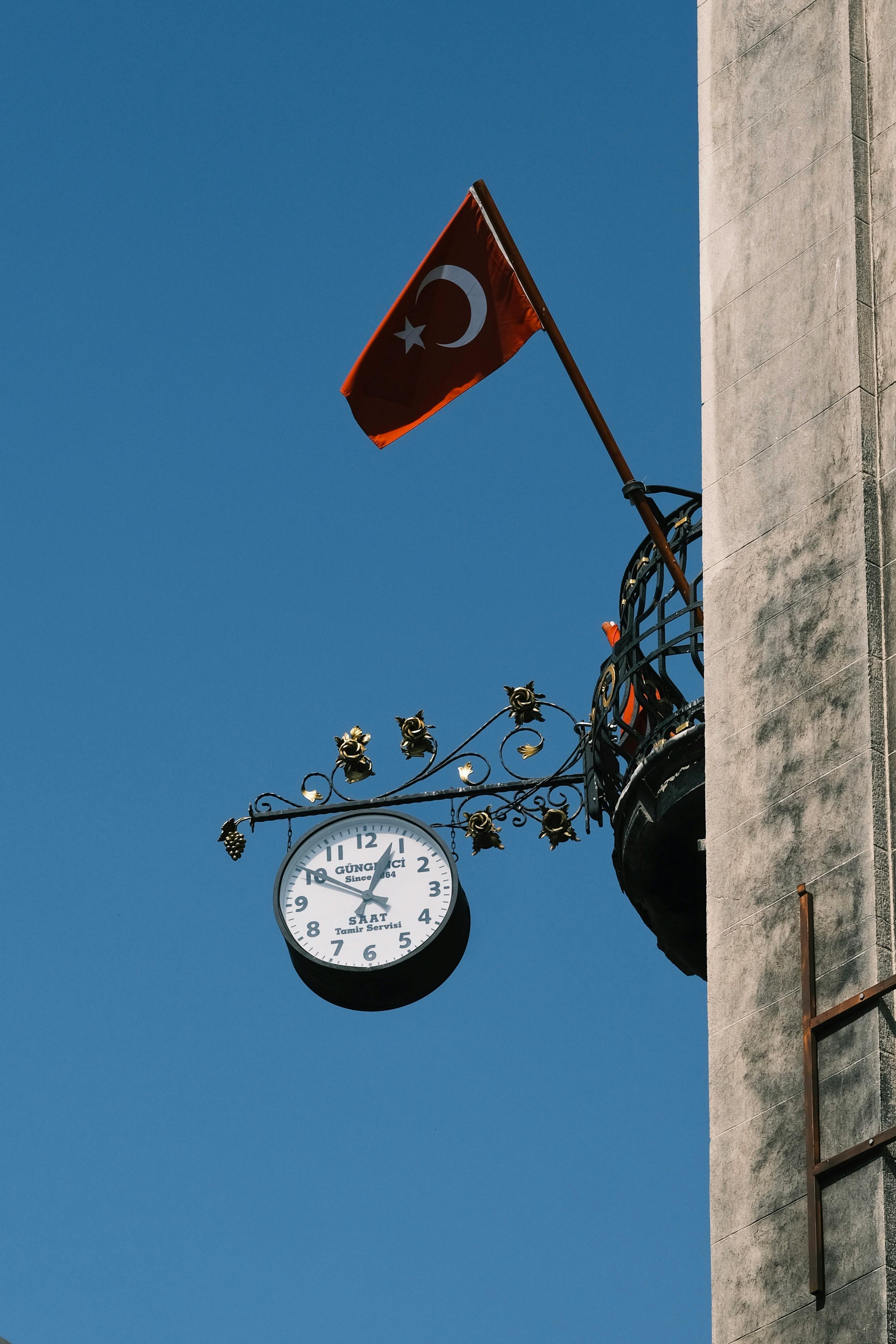 Low Angle Shot of a Building Wall with a Clock and Turkish Flag · Free ...