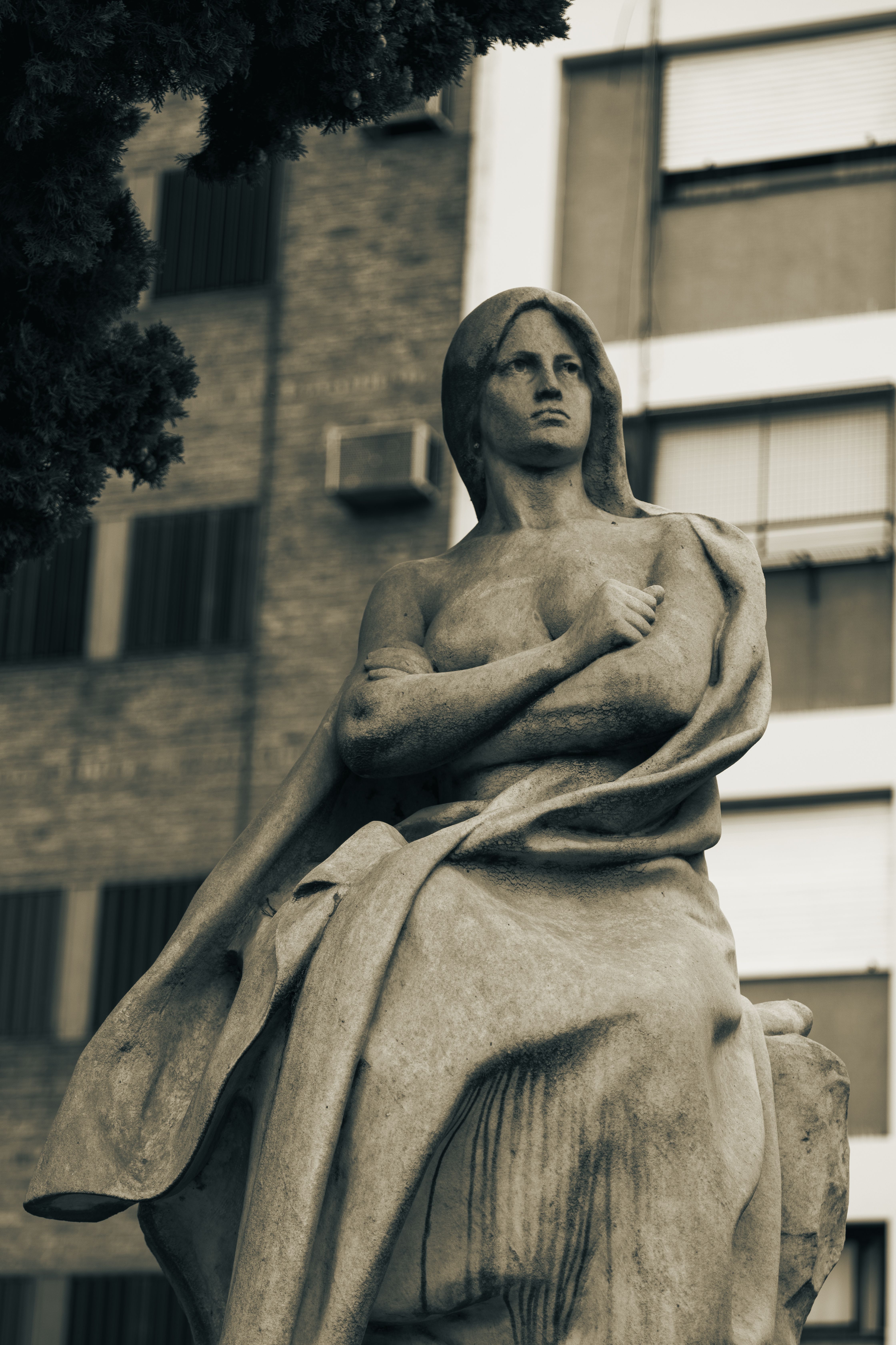 A Woman Leaning on a Statue · Free Stock Photo