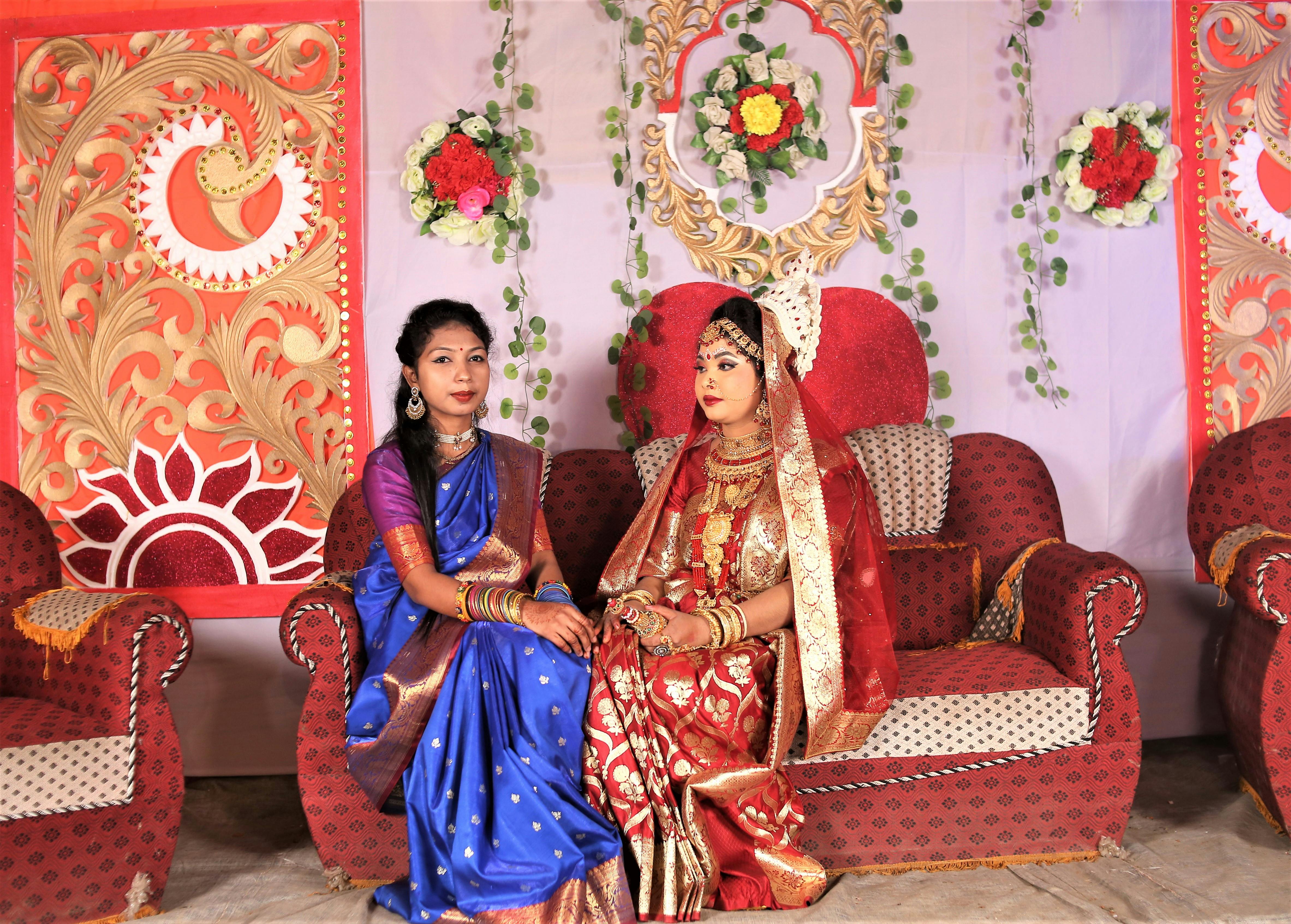 Bride and Her Sister in Traditional Clothing Sitting on a Sofa · Free ...