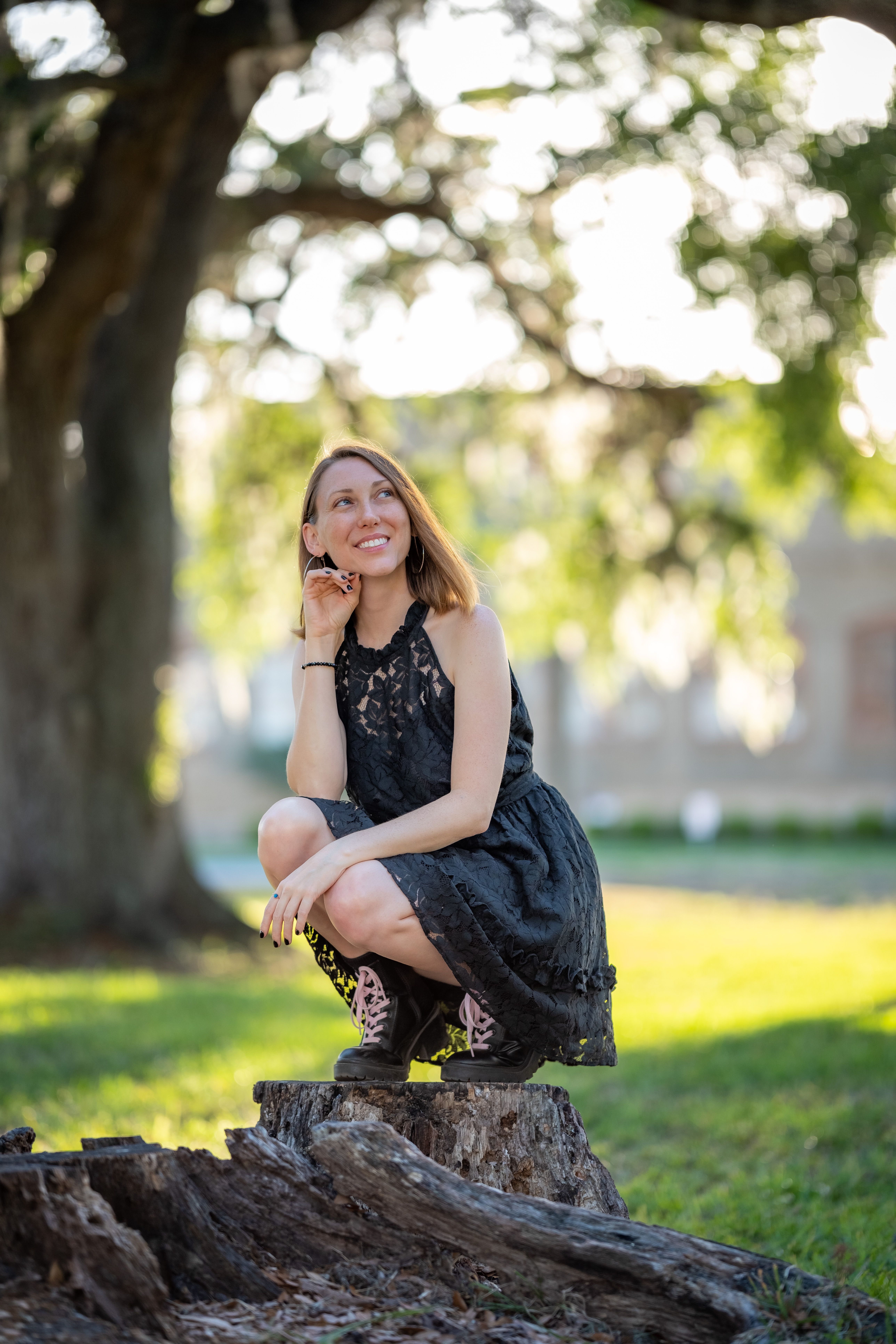 A woman in black dress sitting on a stump · Free Stock Photo
