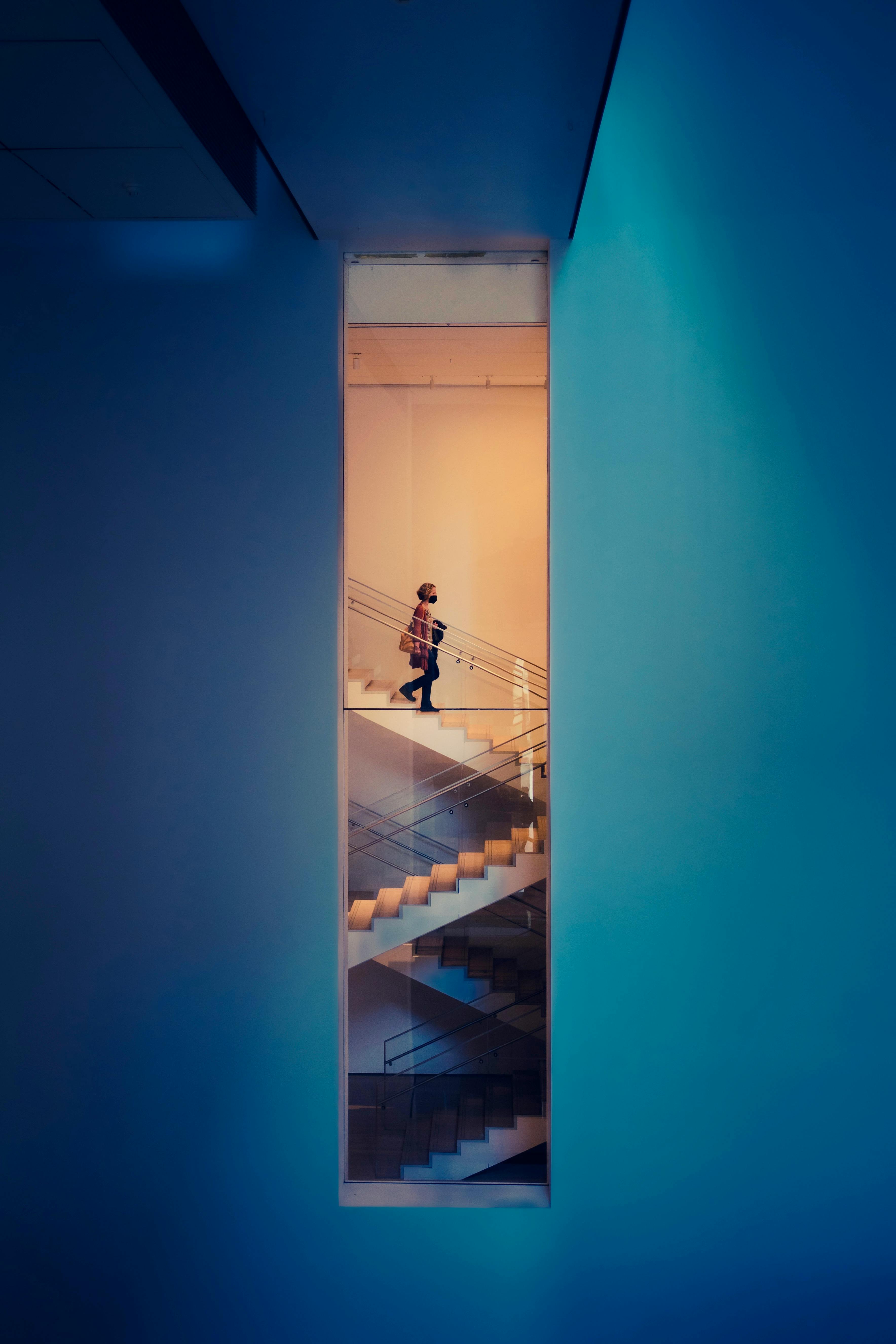 Man Walking Downstairs by Monumental Colonnade · Free Stock Photo