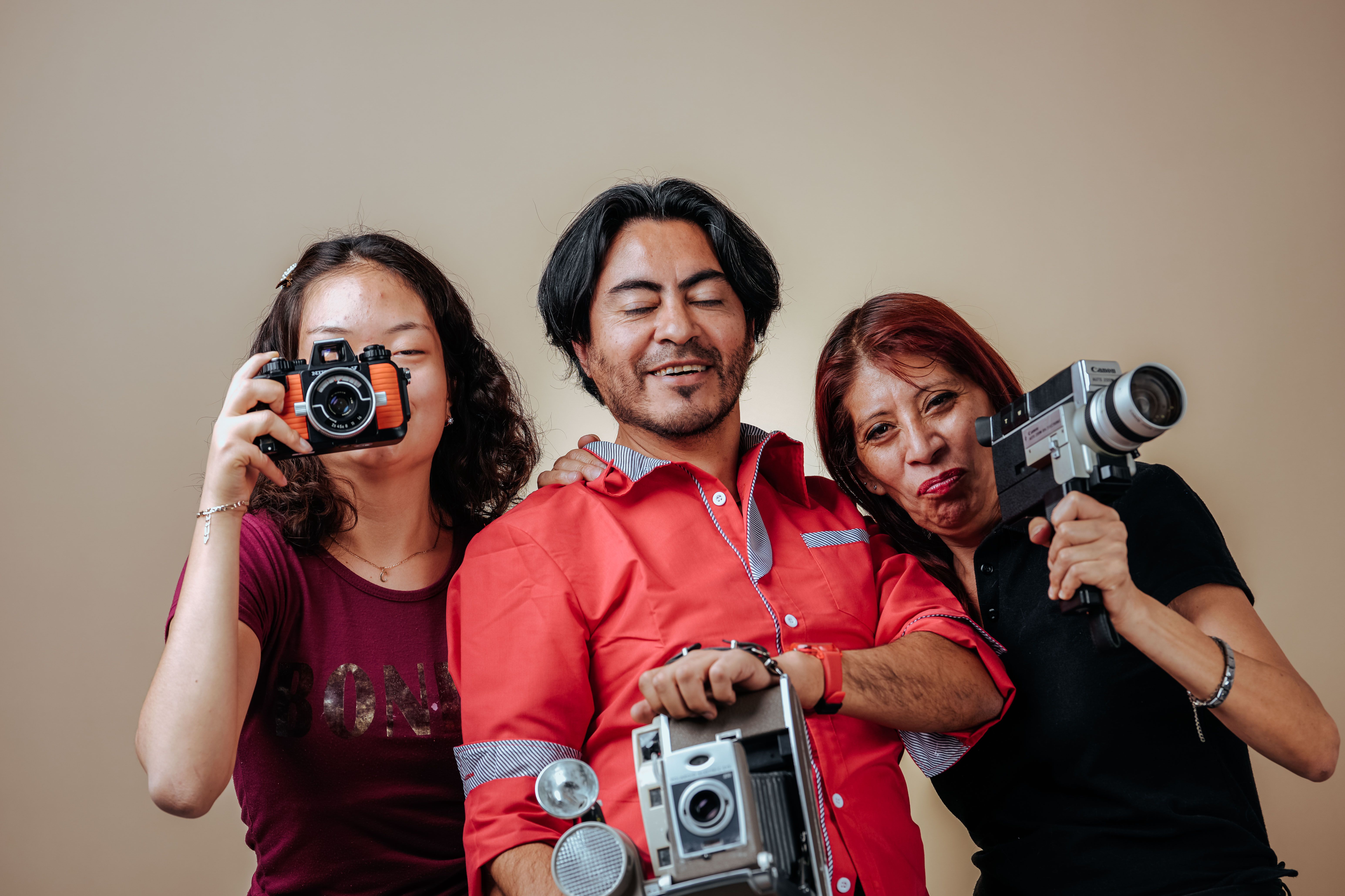 Smiling Man and Women with Cameras · Free Stock Photo