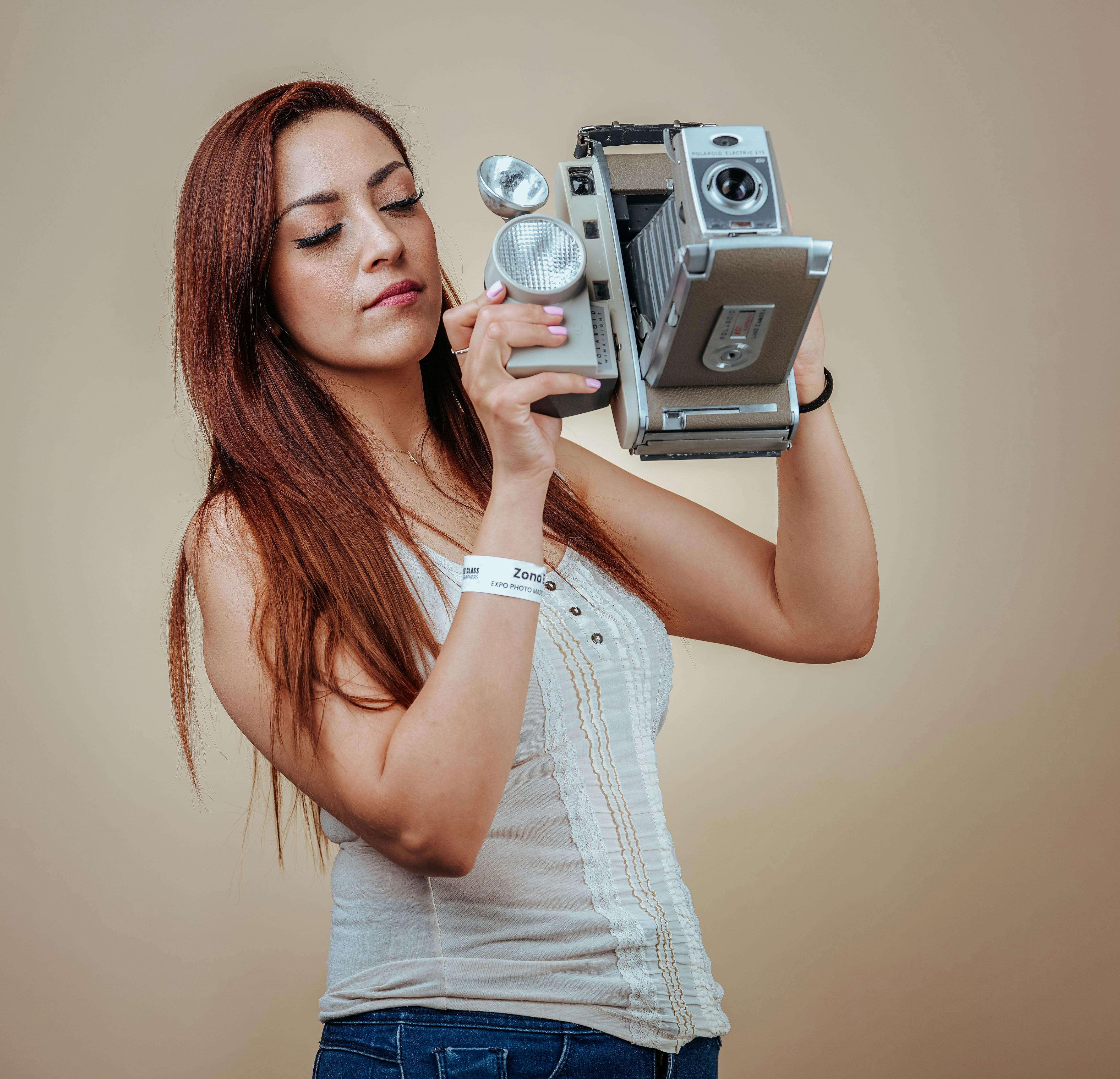 Woman Sitting on Stairs Holding Camera · Free Stock Photo