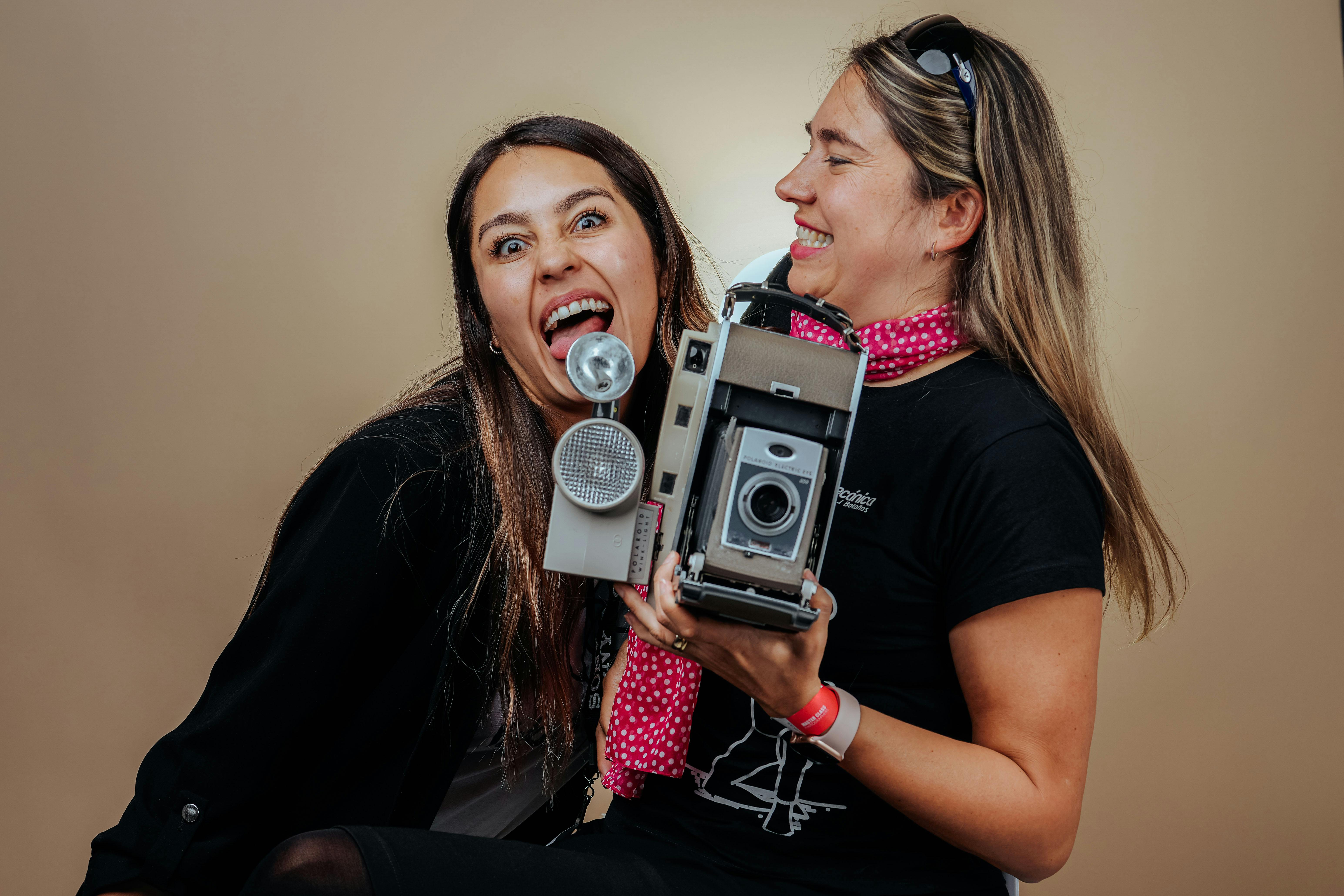 Smiling Women with Cameras · Free Stock Photo