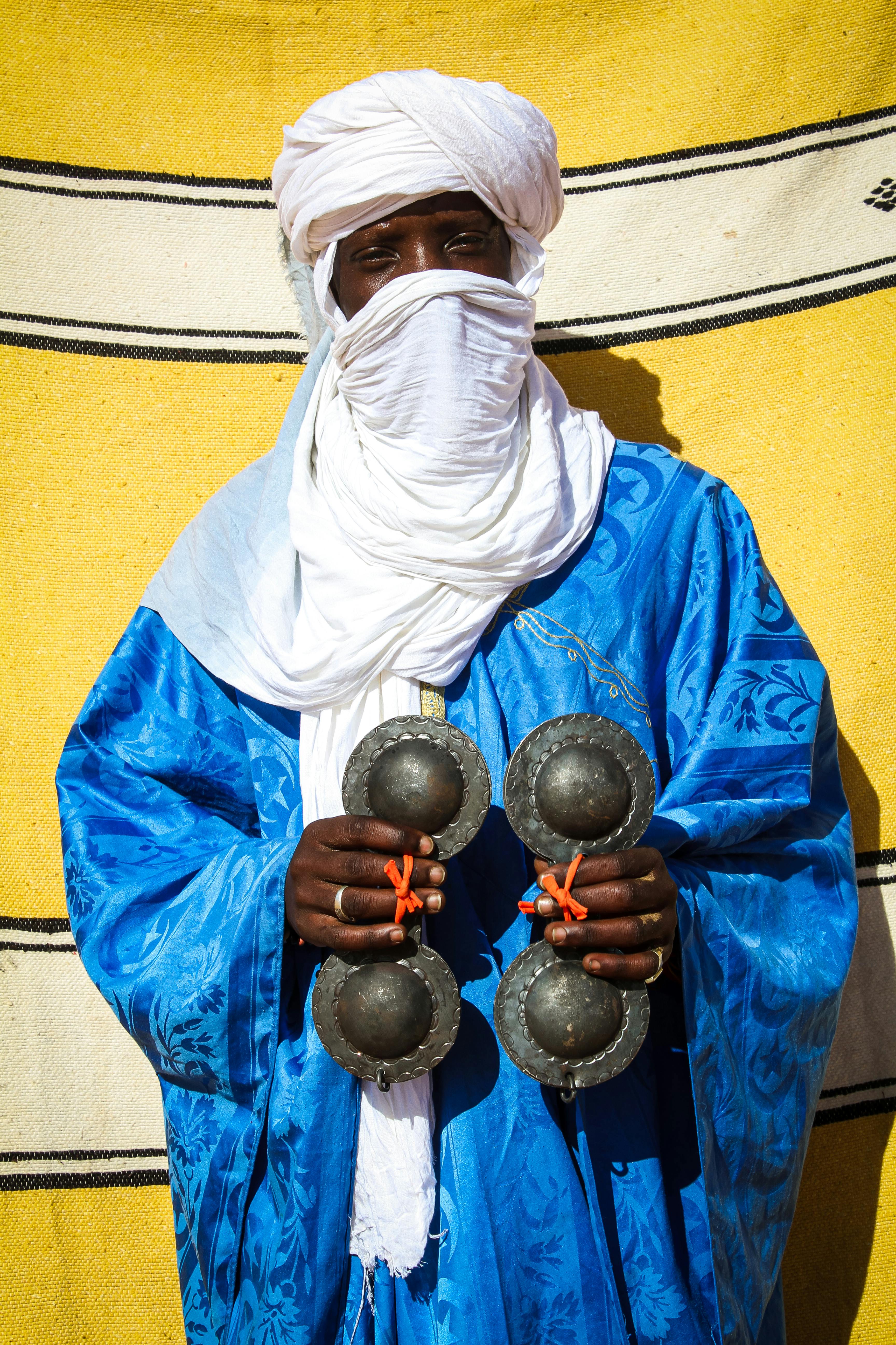 Man in Traditional Clothes Holding Set of Krakeb Instruments · Free ...