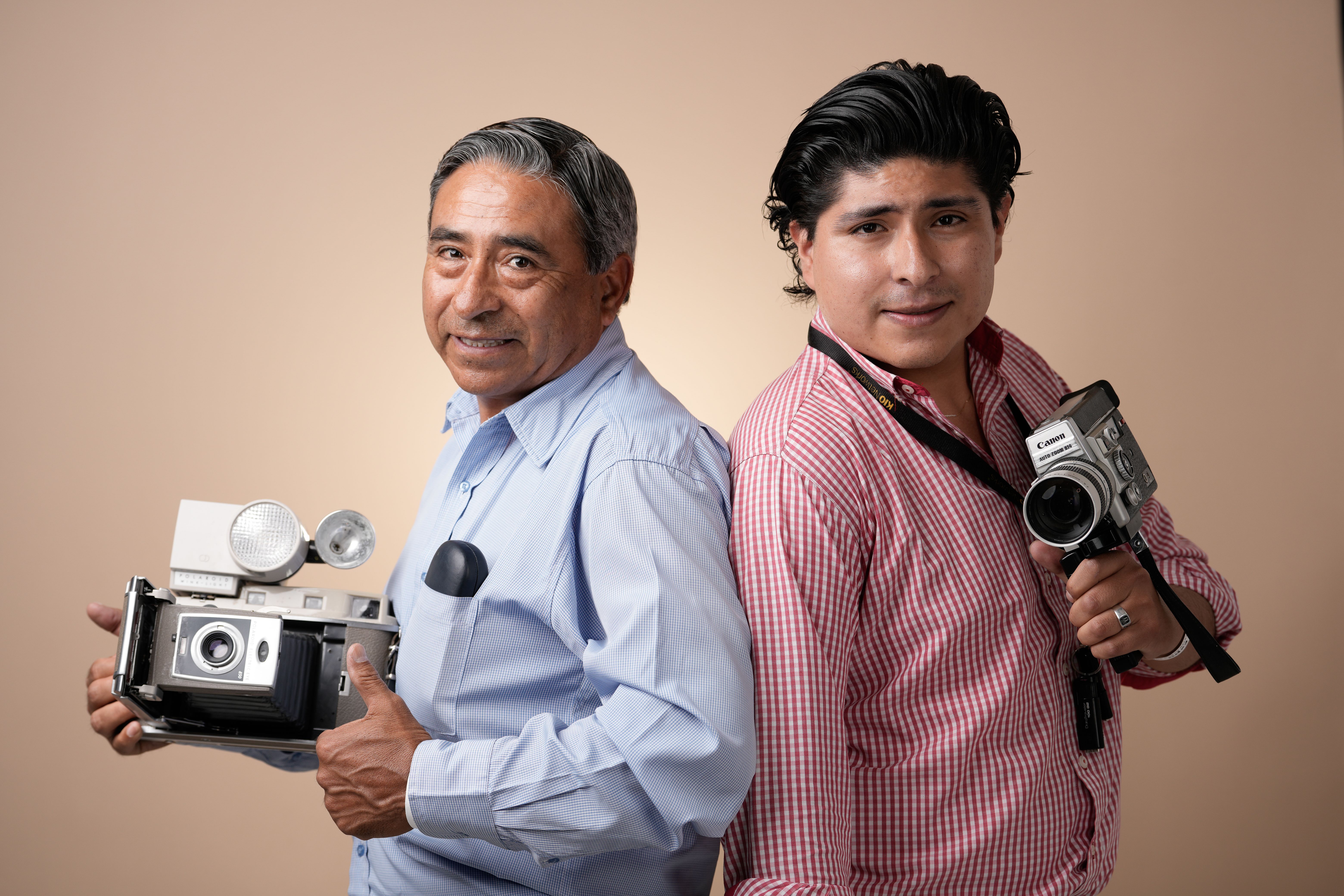 Portrait of Men Posing with Cameras · Free Stock Photo