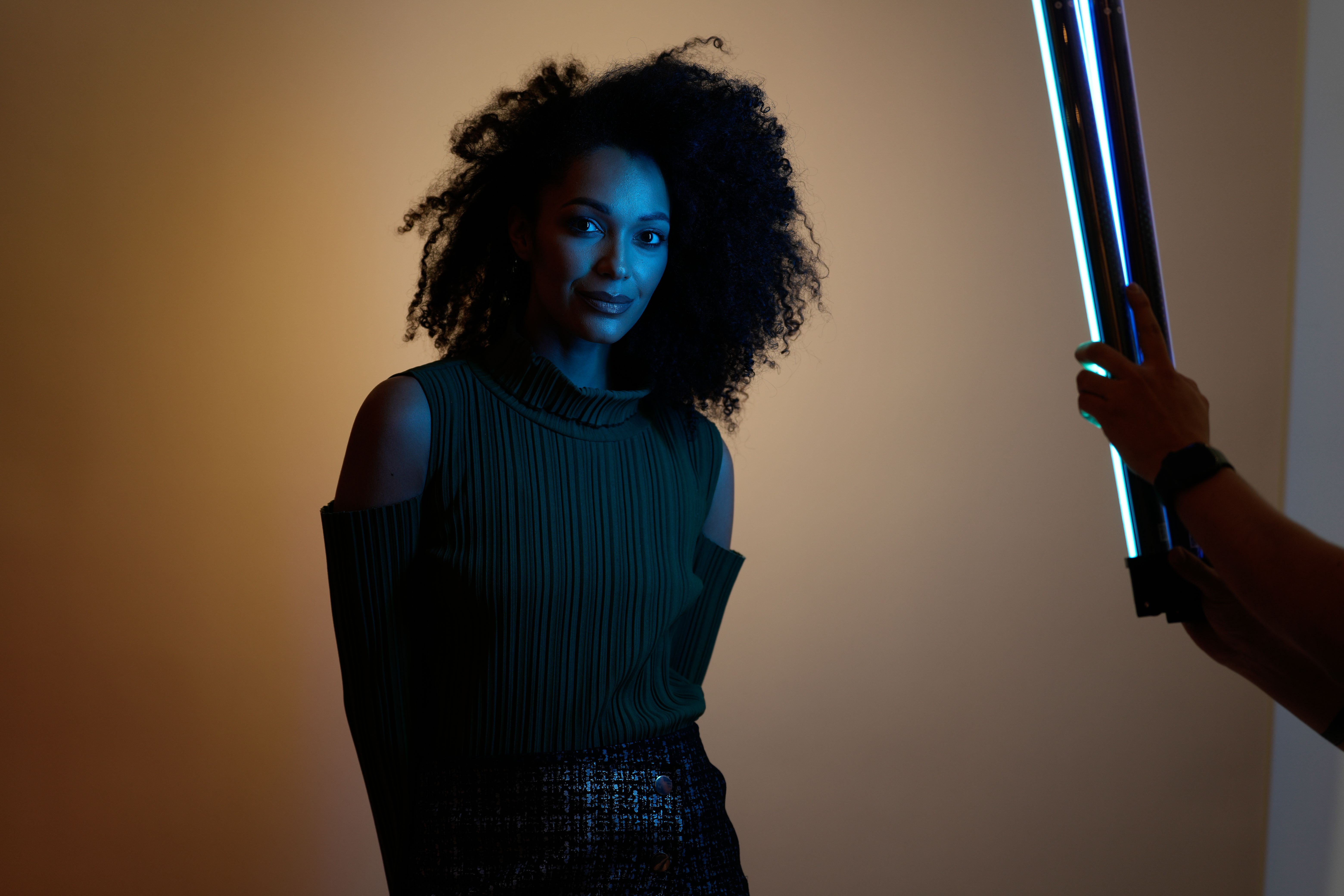 Beautiful Woman Posing in Studio in Blue Neon Spotlight · Free Stock Photo