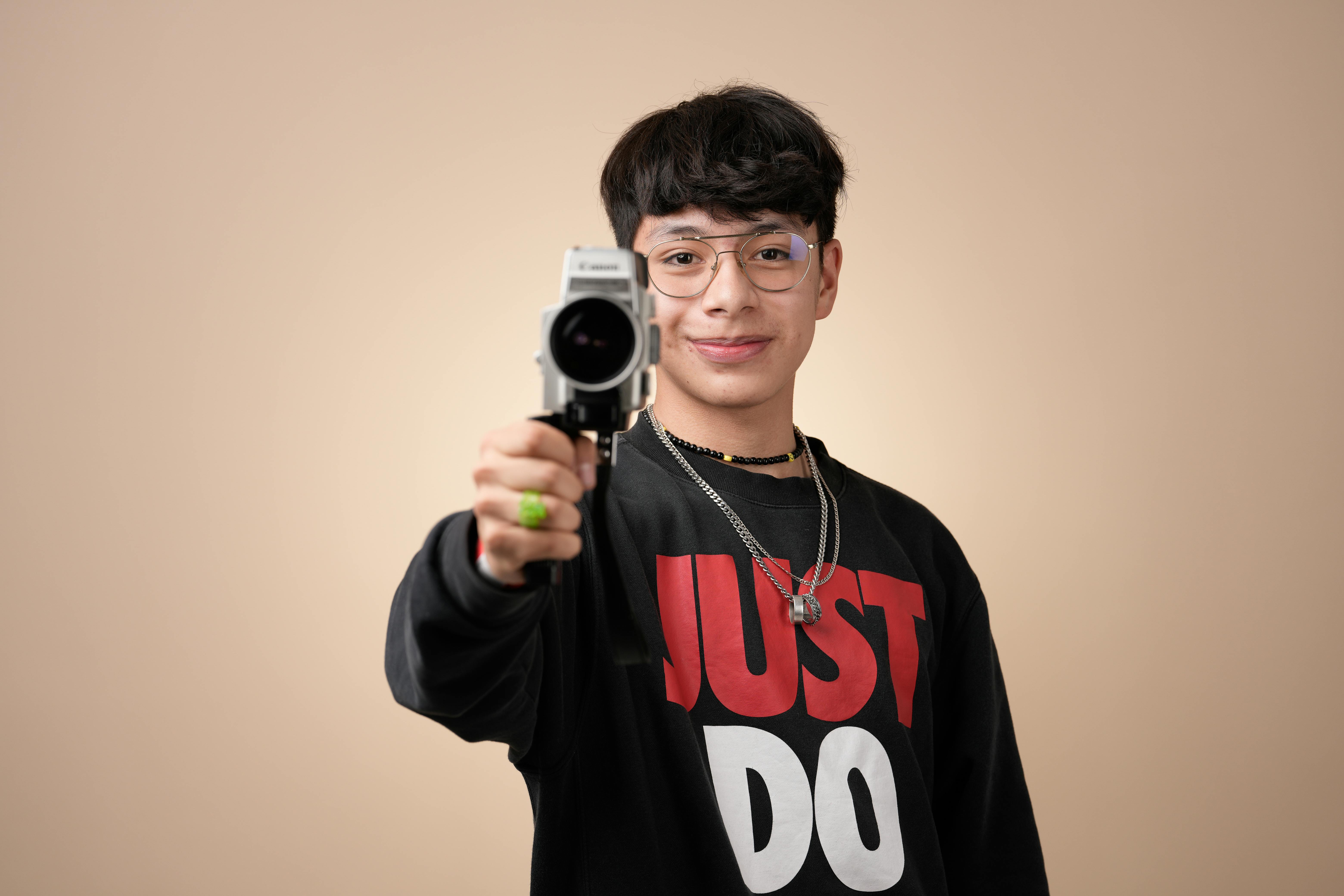 Grayscale Portrait Photo of Man Wearing Holding a Camera · Free Stock Photo