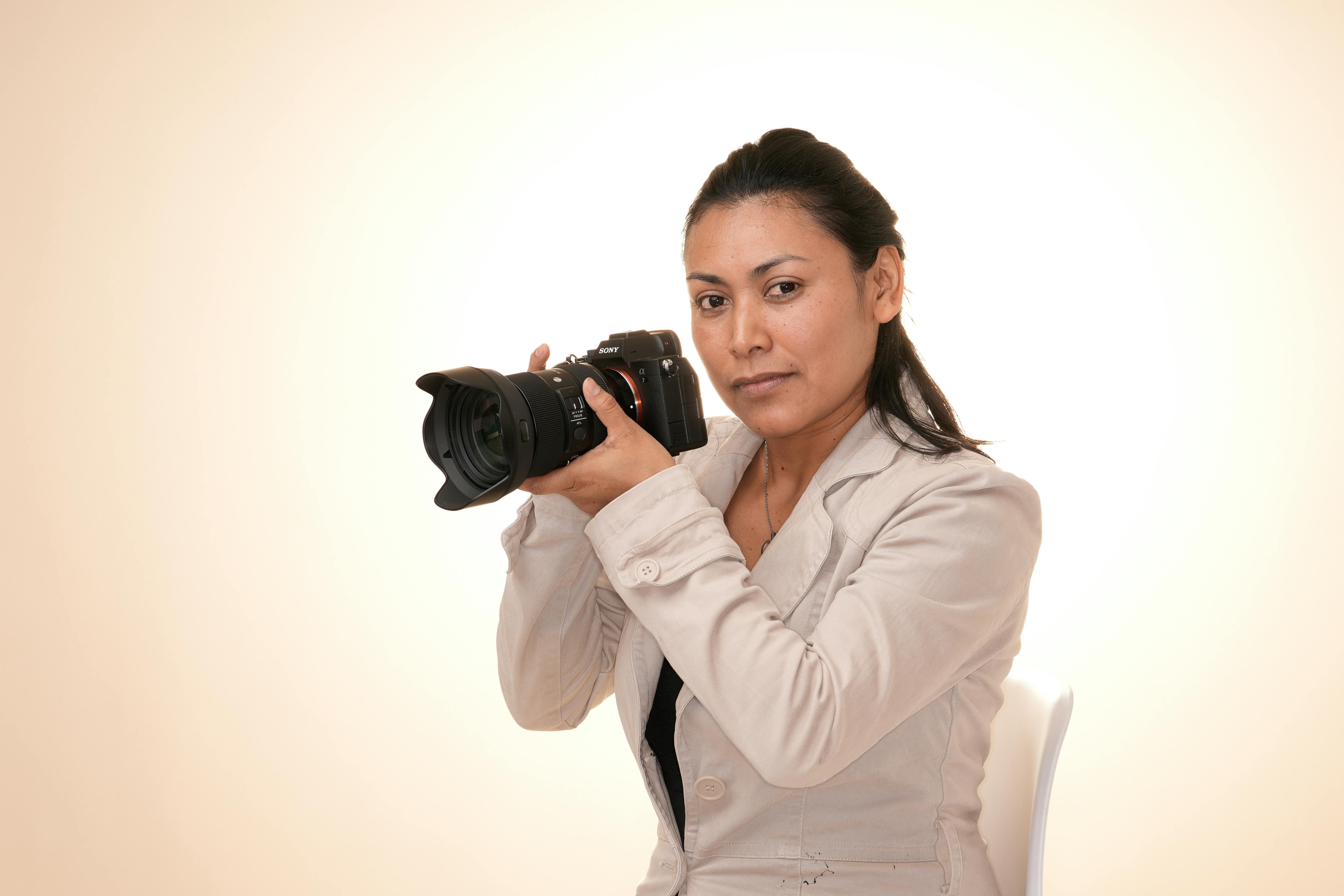 Potrait of Woman Holding Up Camera · Free Stock Photo