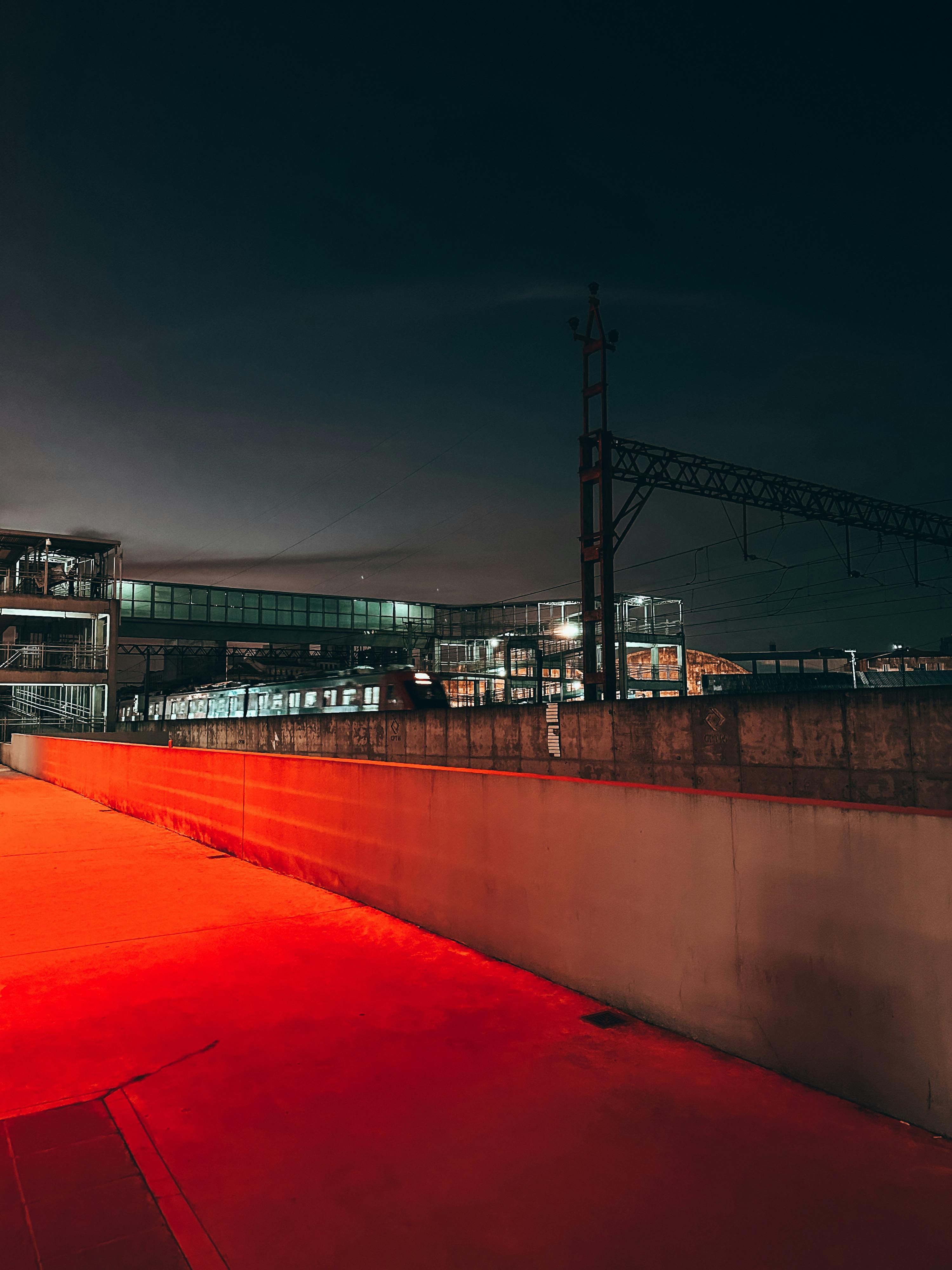 Red Light on the Pavement near a Railway Station in City at Night ...