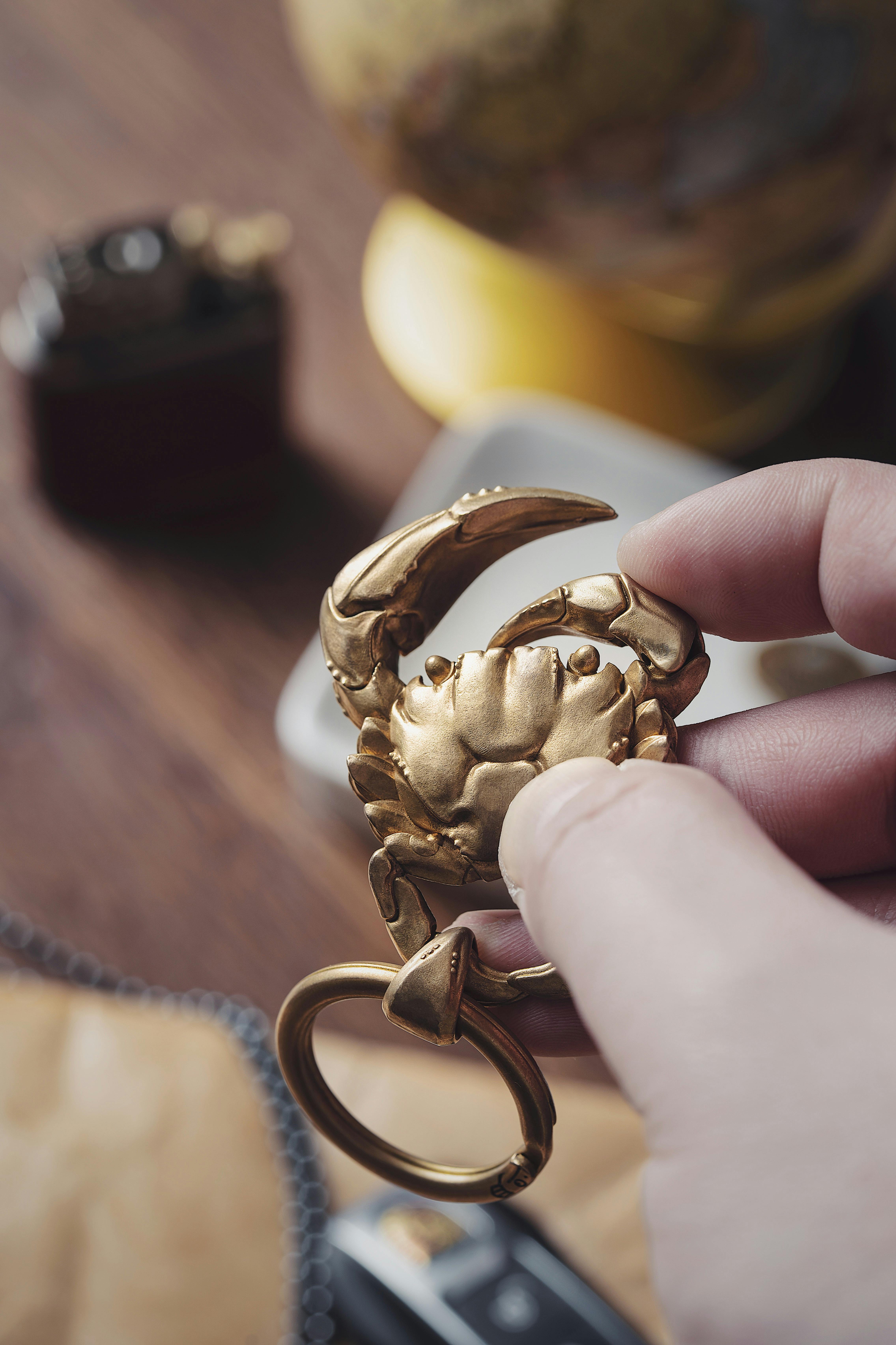 Man Holding a Golden Heart Shape Key Ring · Free Stock Photo